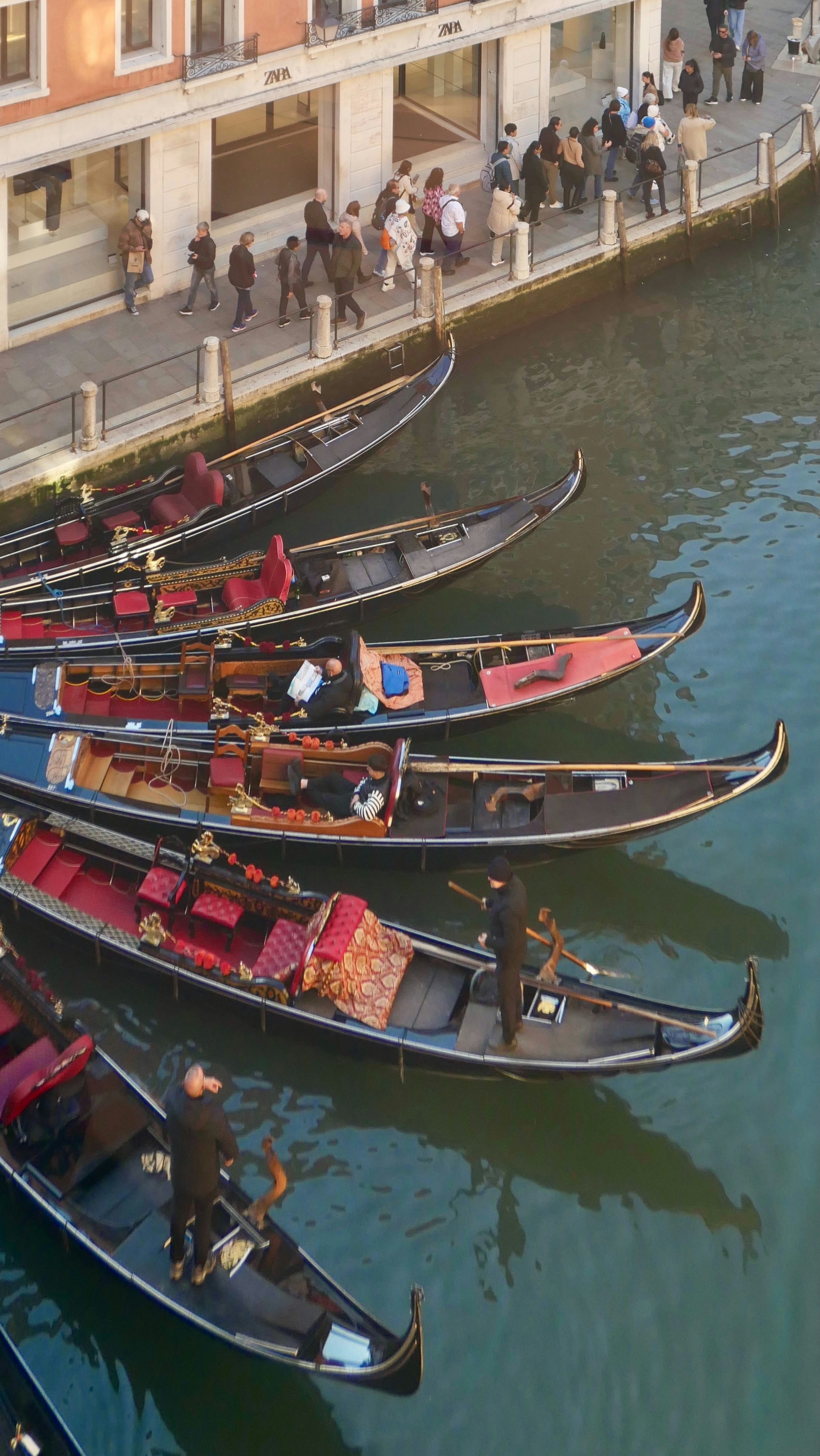 Gondola Row Along a Lively Venetian Canalfront