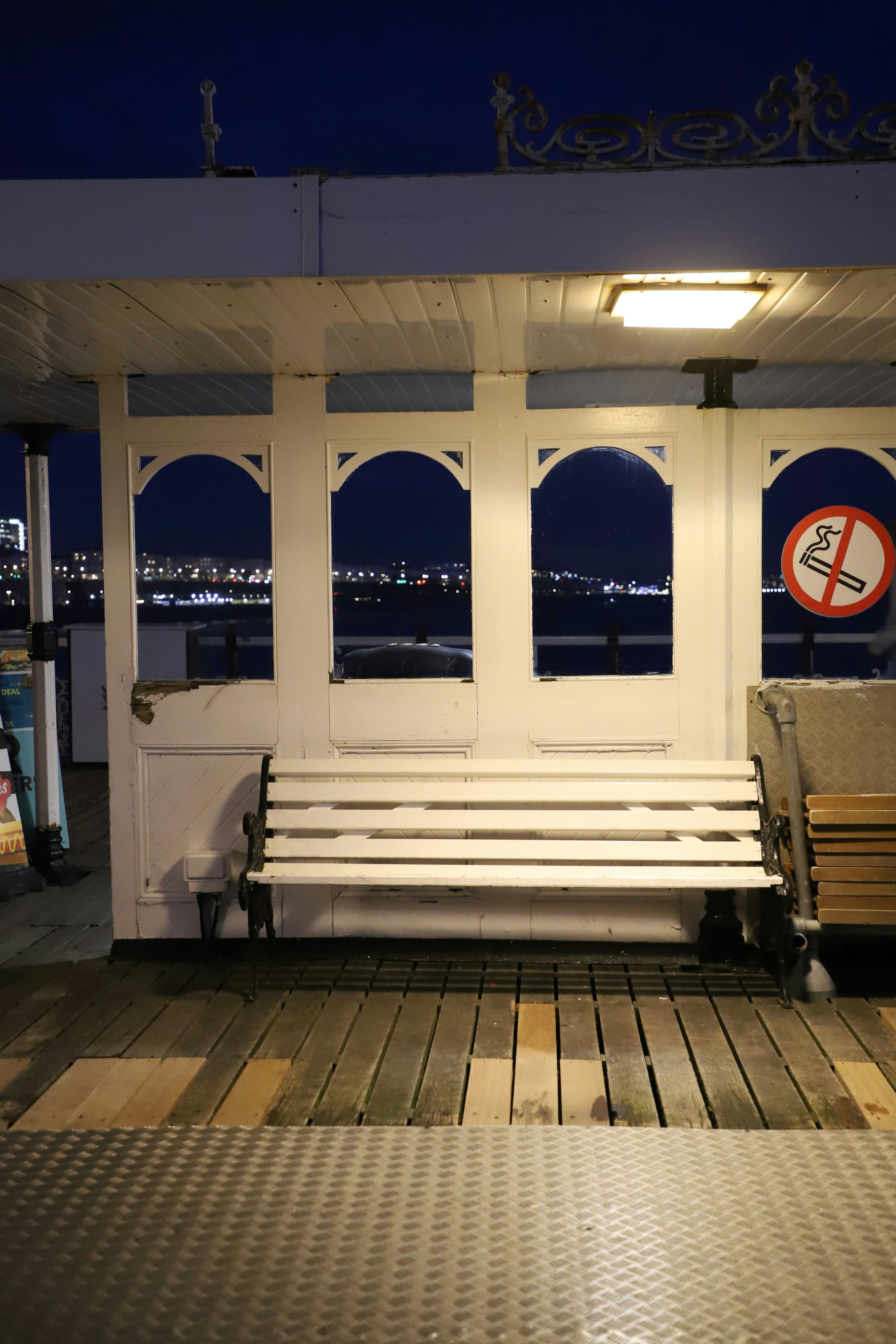 Moonlit Pier Bench Framed by Arched White Panels