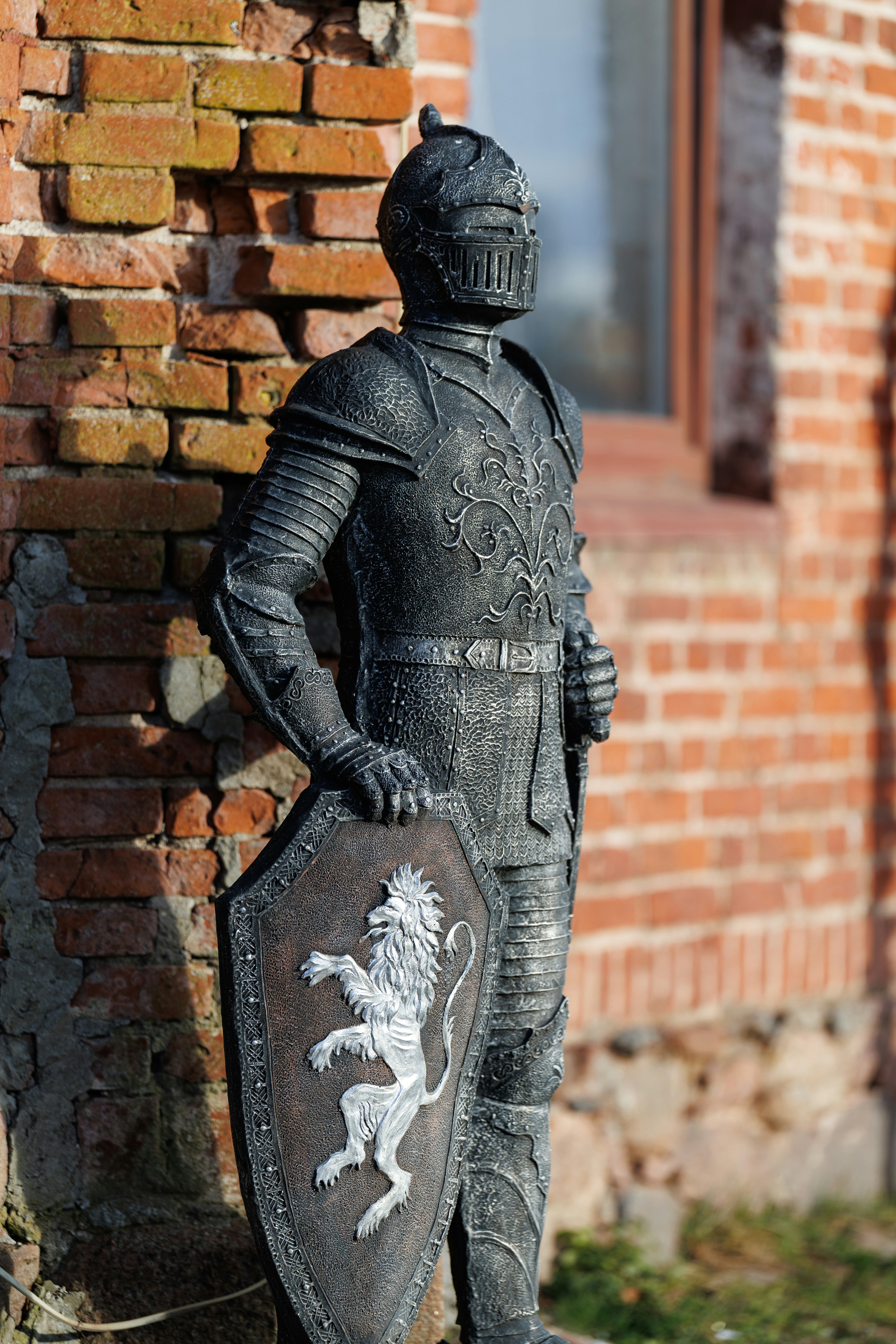 Heraldic Sentinel: Knight in Weathered Armor Guarding a Lion-Shield by Brickwork