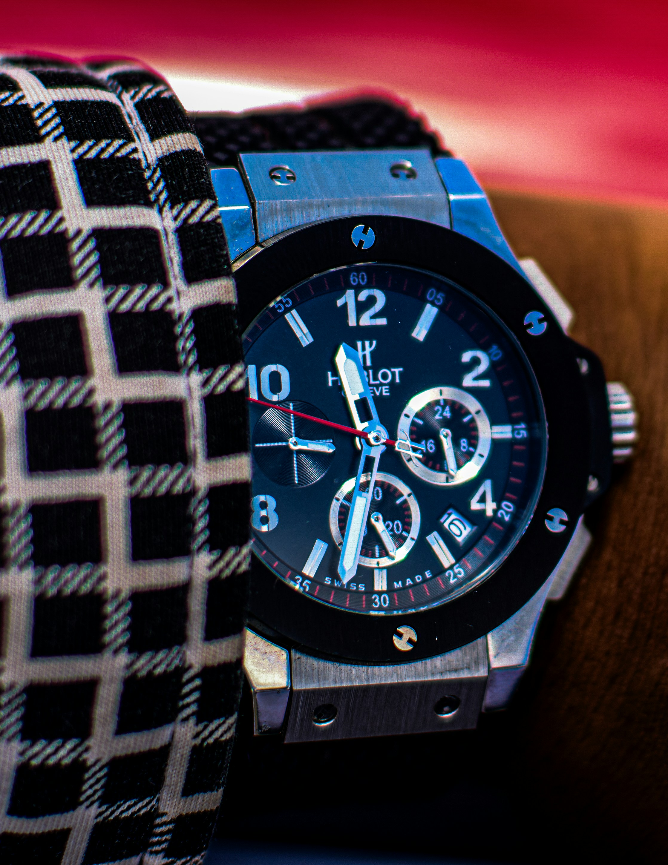 Industrial Chronograph on a Checkered Sleeve: A Close-Up of Steel, Screws and Subdials