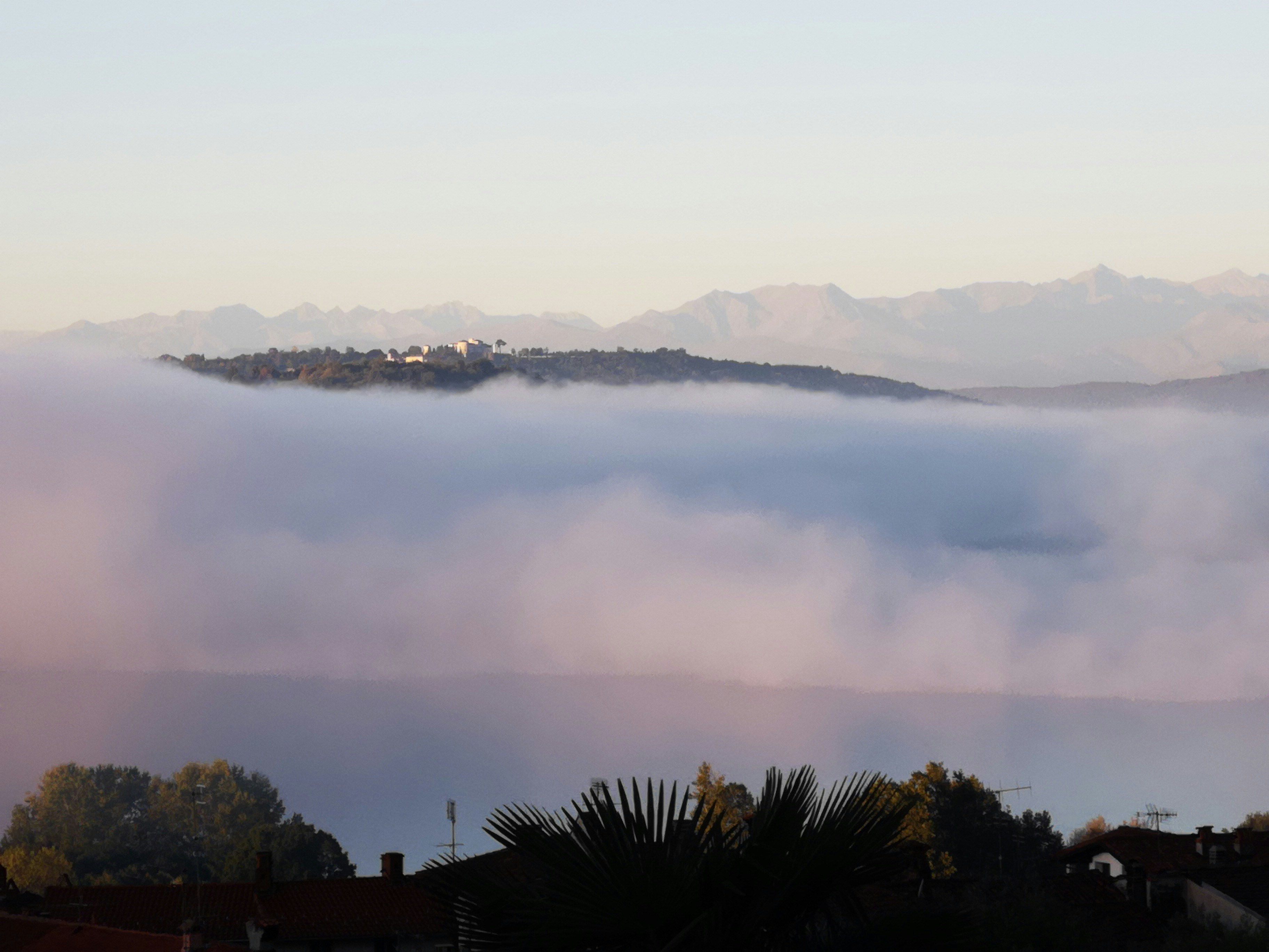 Dawn Veil on the Ridge: Village Silhouettes Amid Morning Fog