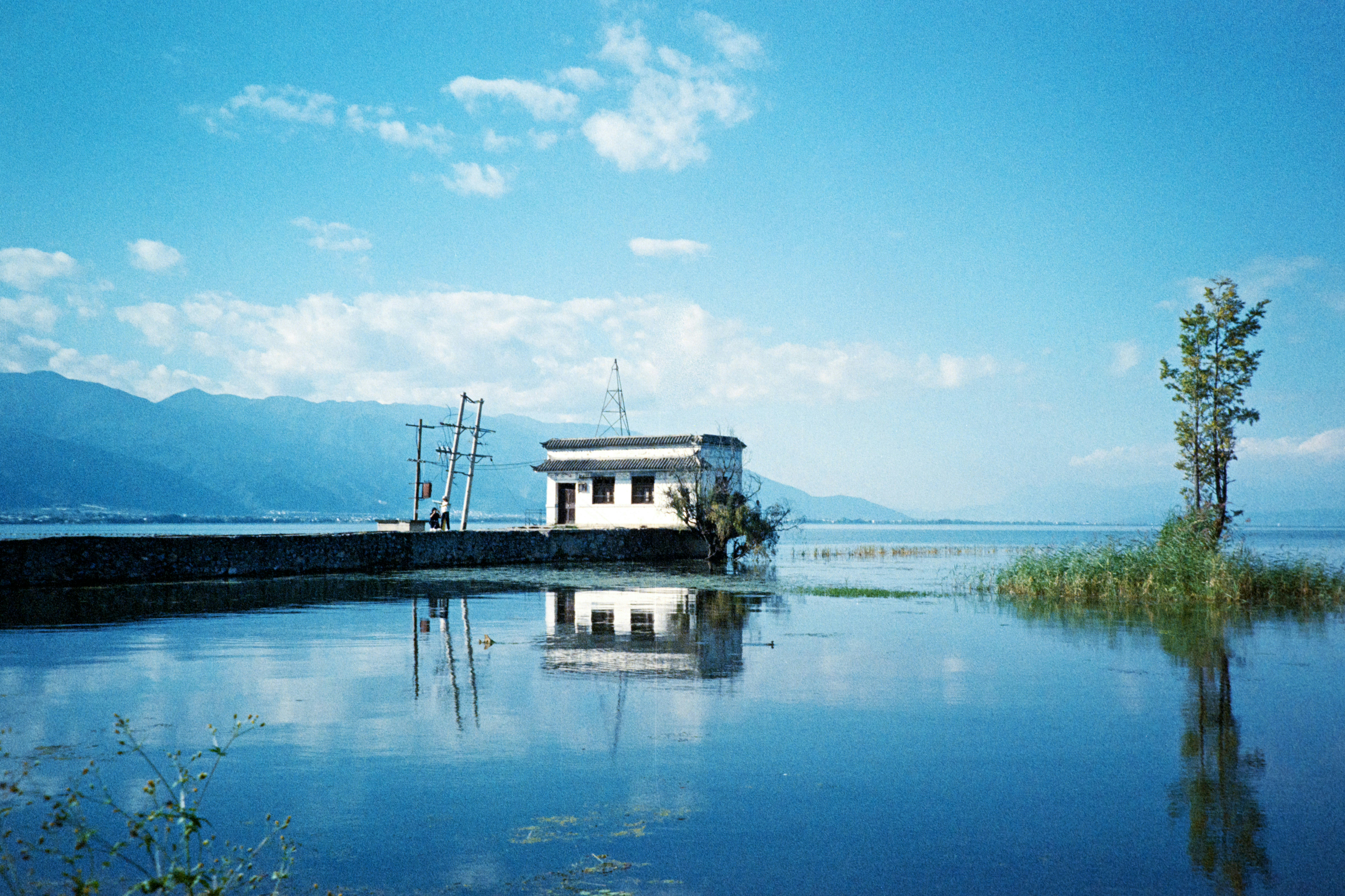 Blue Silence: A Boathouse at the Edge of a Glassy Lake