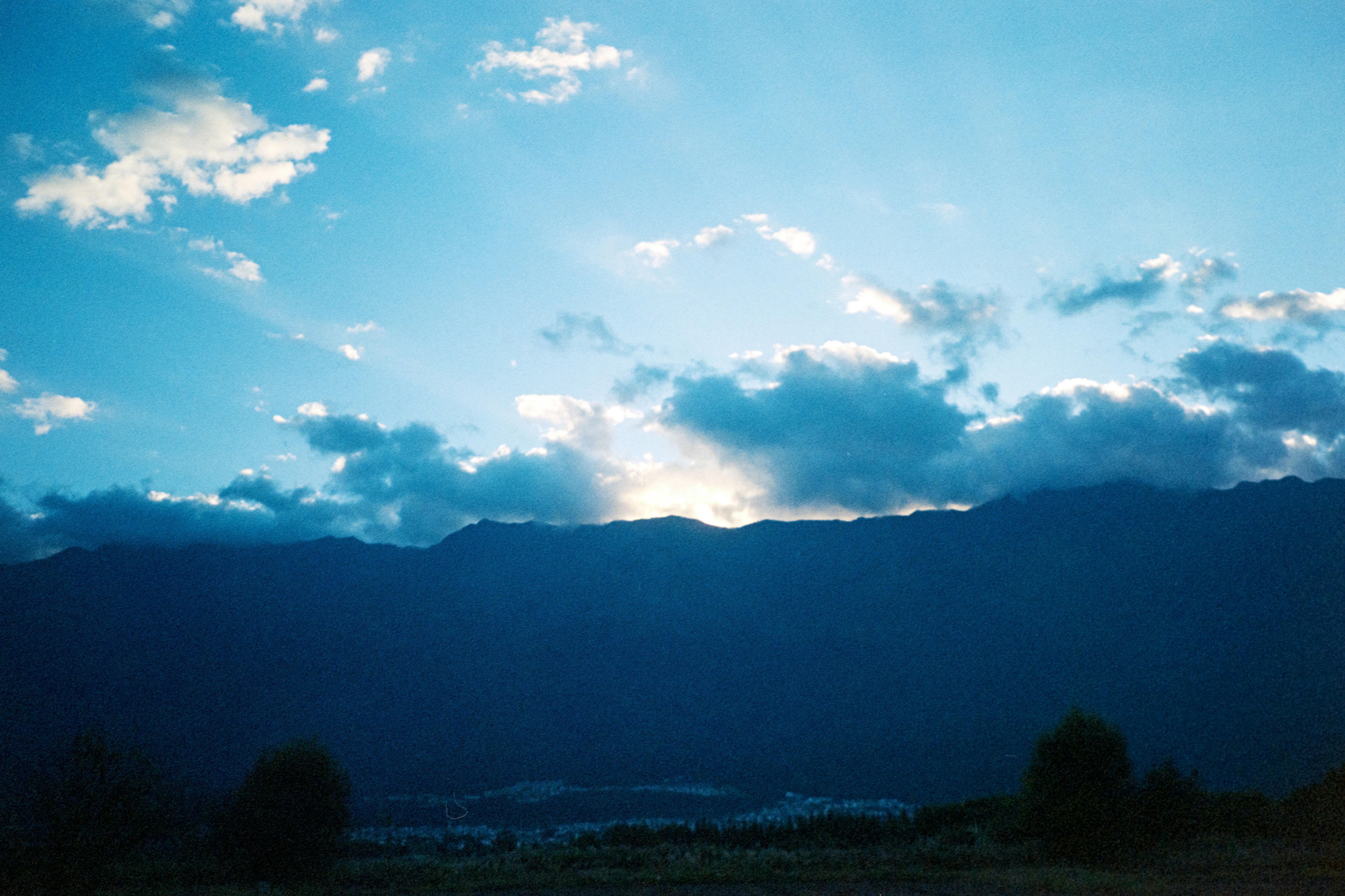 Distant Ridge at Sundown: Quiet Valleys Below a Hushed Sky