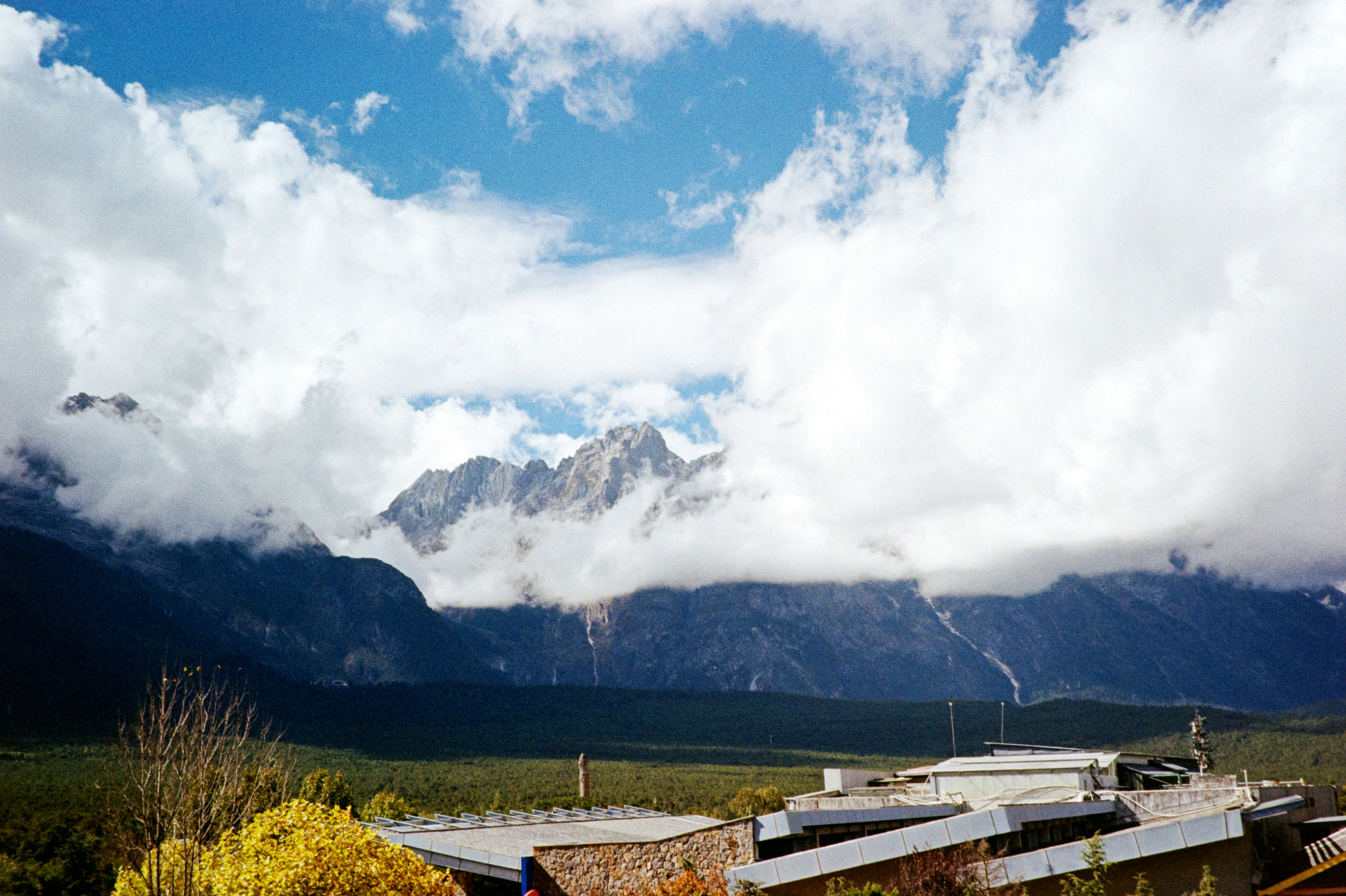 Cloud-kissed Peaks Over a Quiet Valley Town