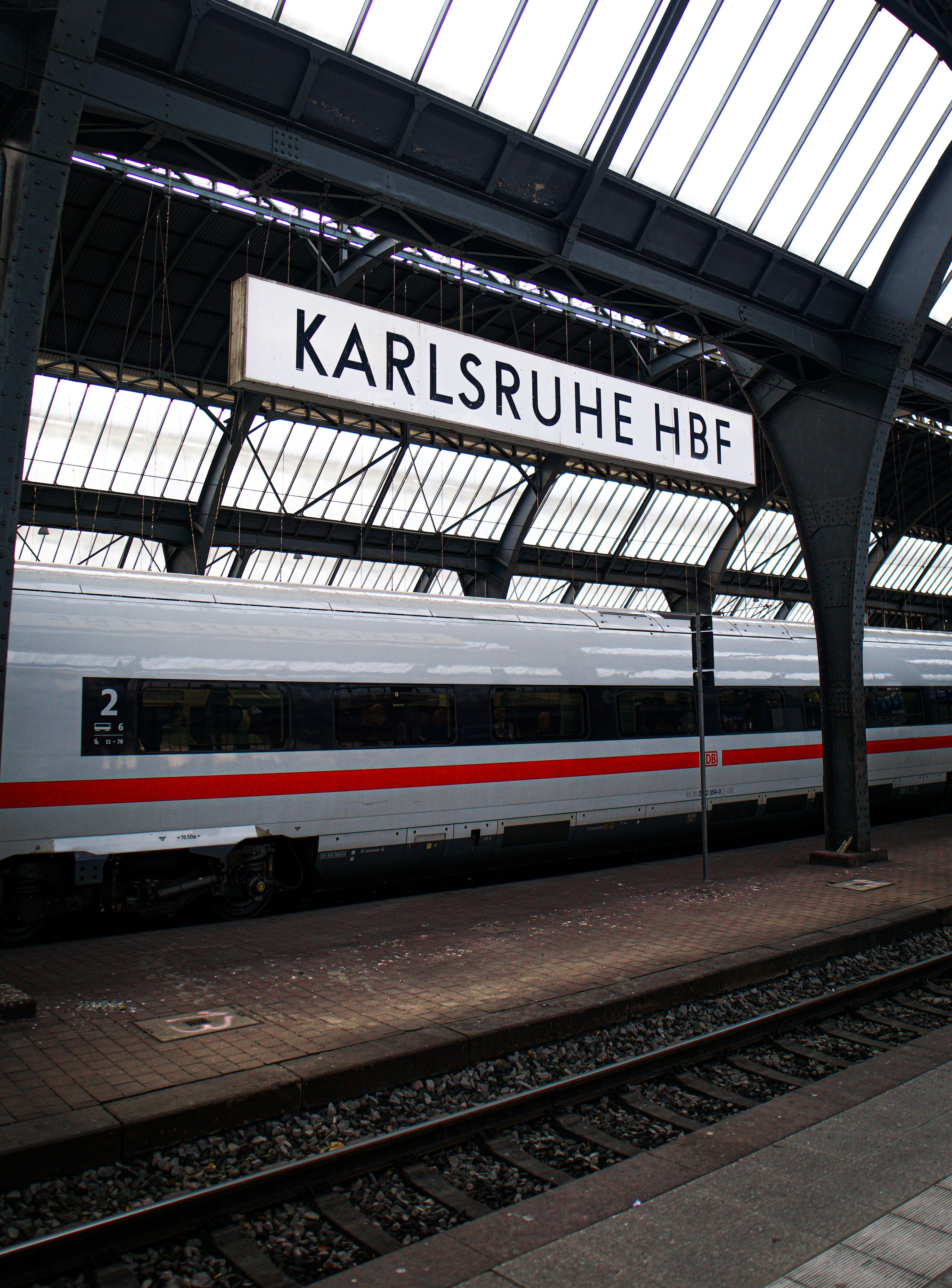 Karlsruhe HBF Platform: Signage, Steel Arches, and a Red-Stripe Intercity