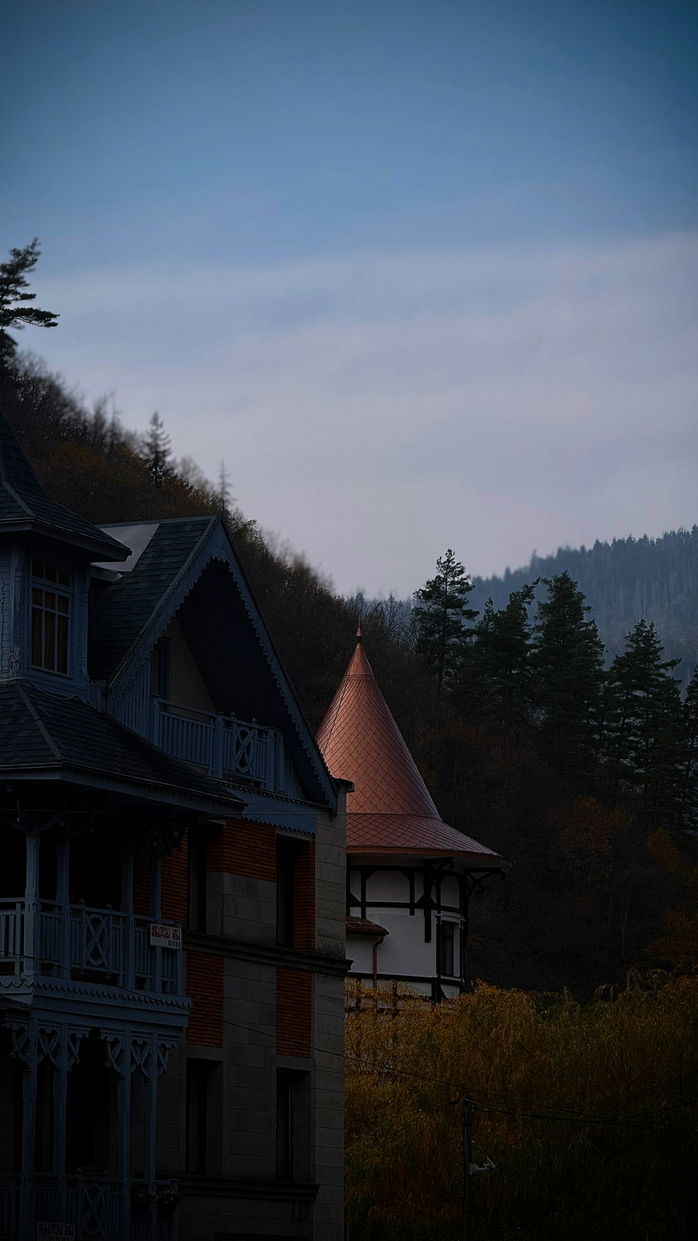 Copper Spire Among Shadowed Gables at Dusk