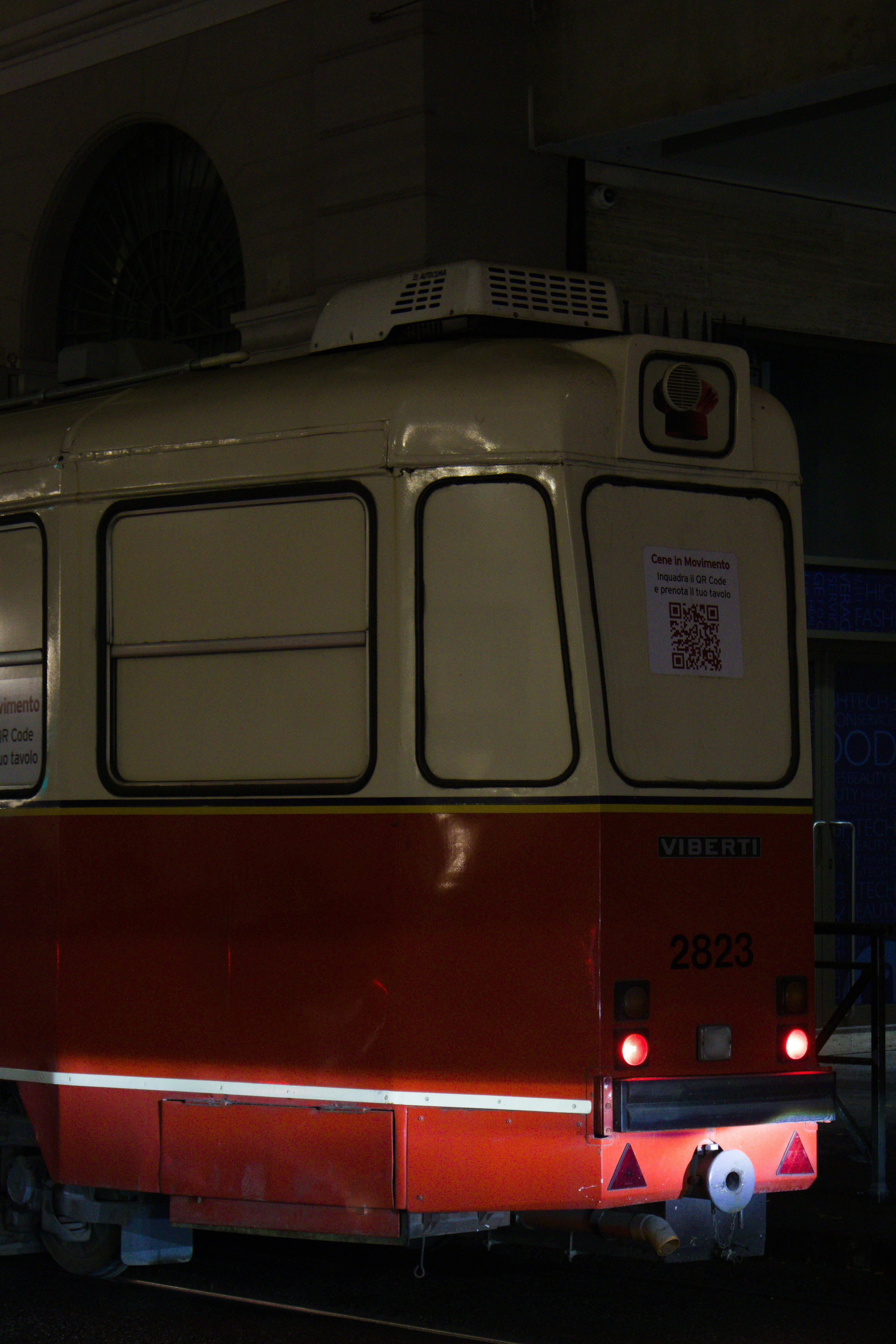 Nightward Tram: A Vintage Red Railcar Waiting at the Urban Edge