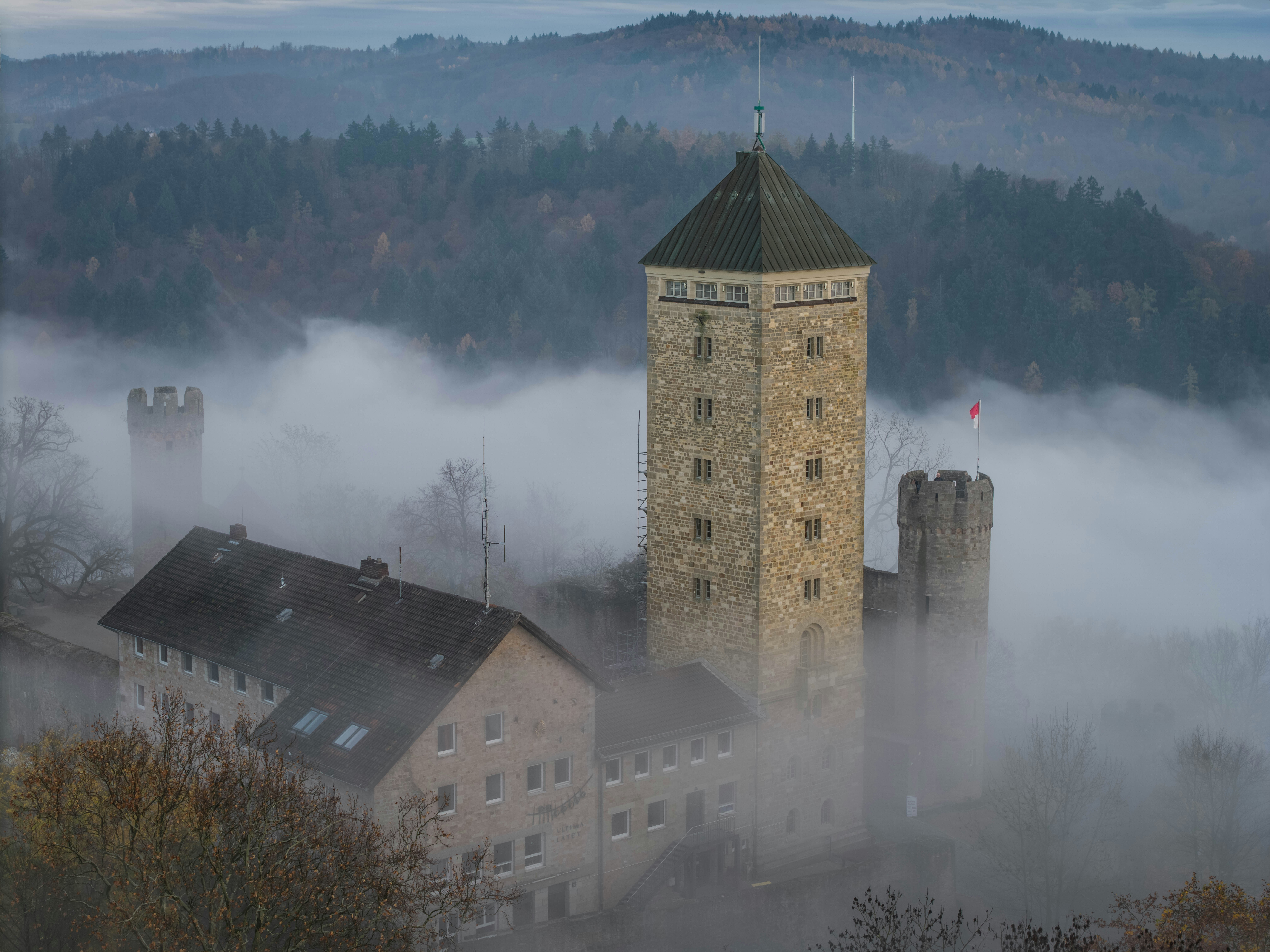 Mist-Laden Keep: Central Tower Emerges Through Fog