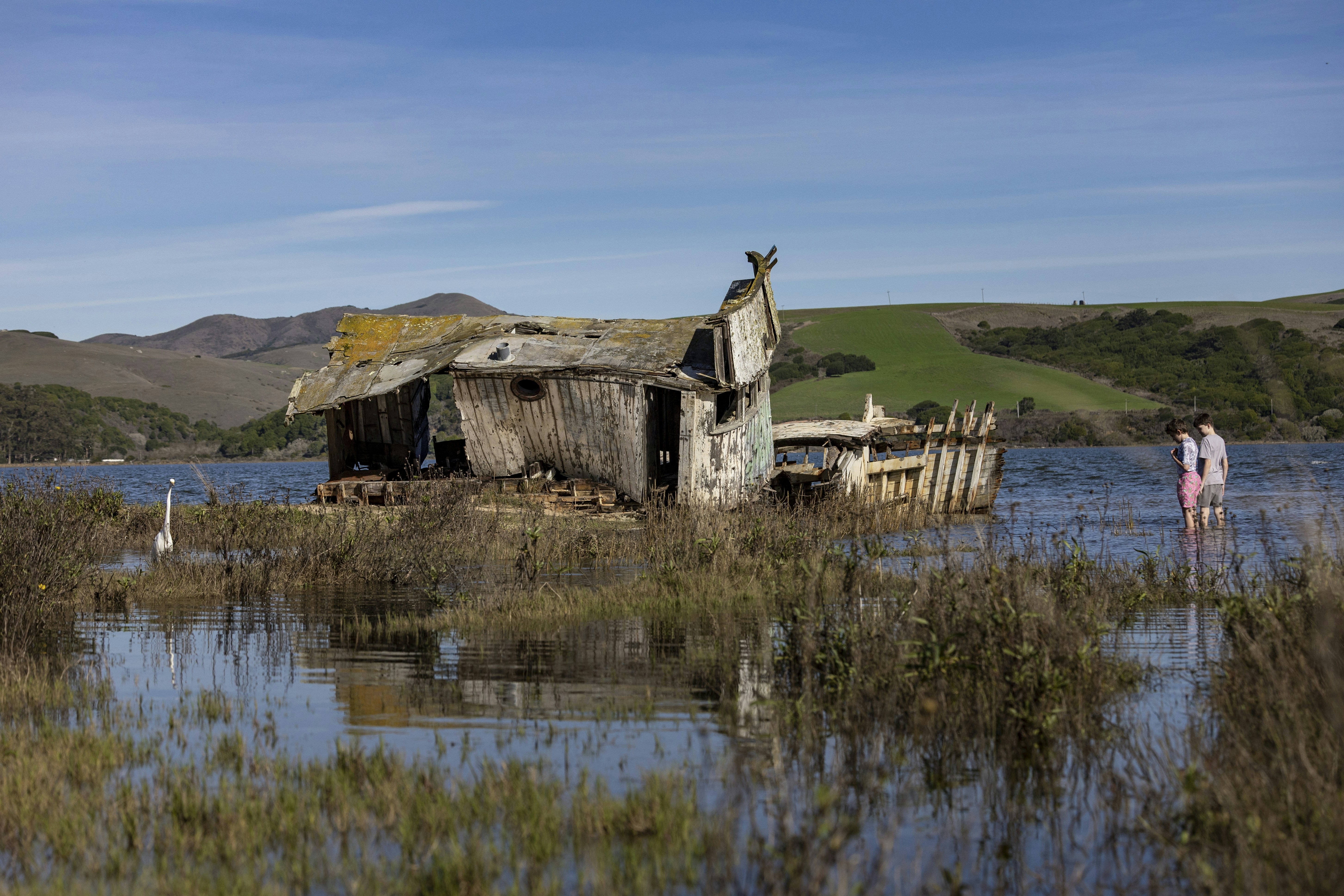 Driftwood Survivor: A Weathered Shack Anchored at the Water's Edge