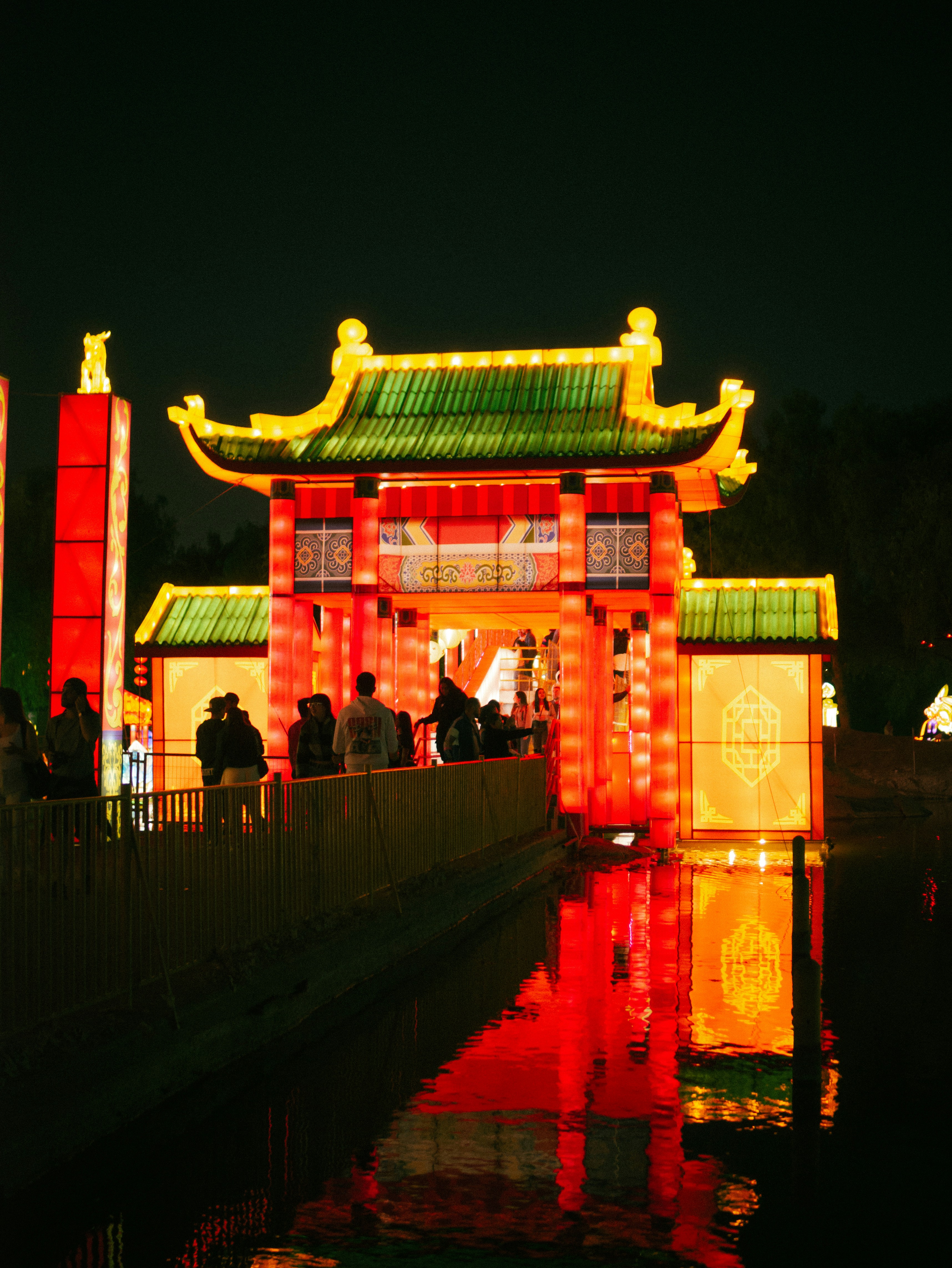 Midnight Lantern Gate: Neon Red Arch Reflected in the Quiet Canal