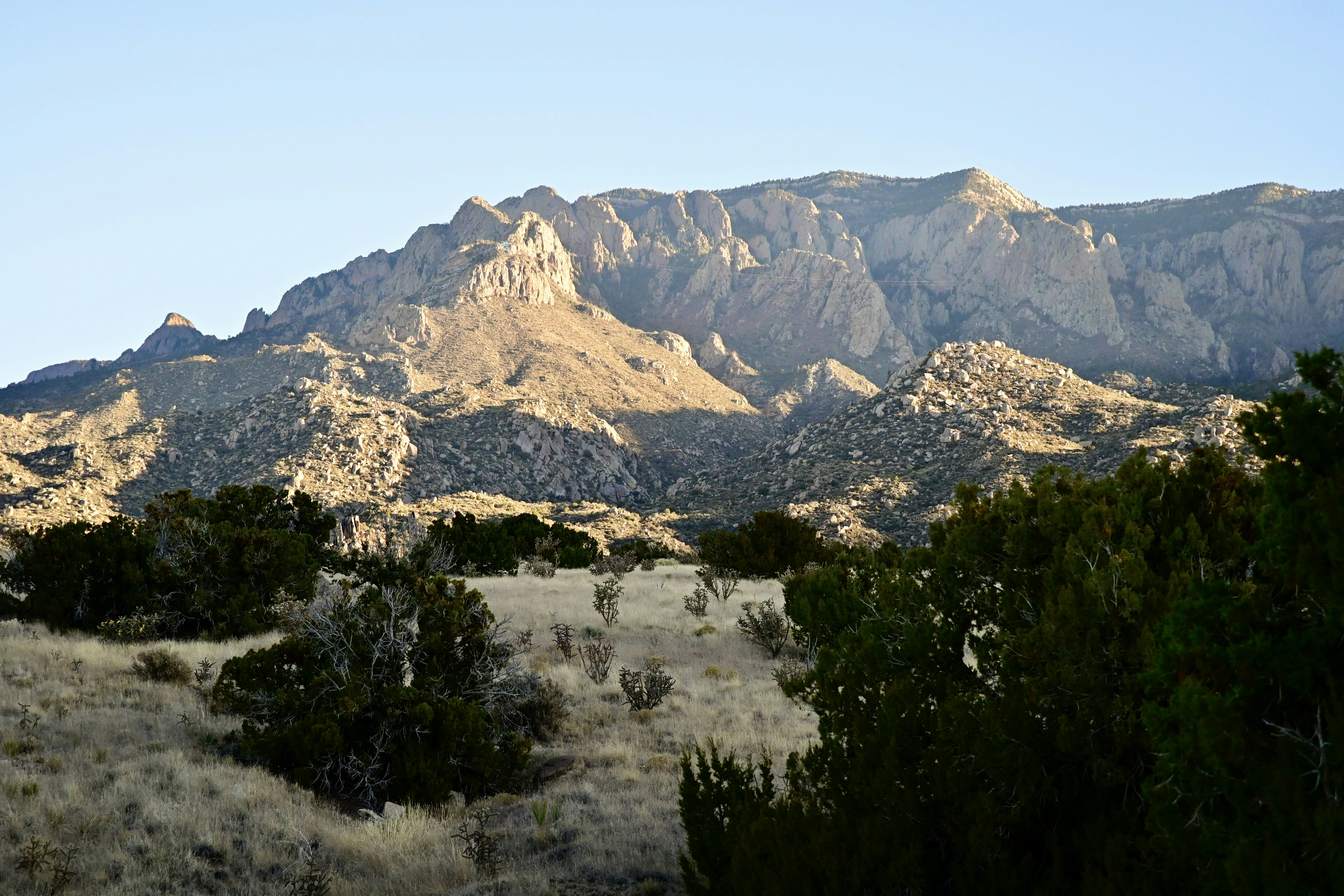 Amber-Ridged Summit Bathed in Late-Day Light Over Desert Scrub
