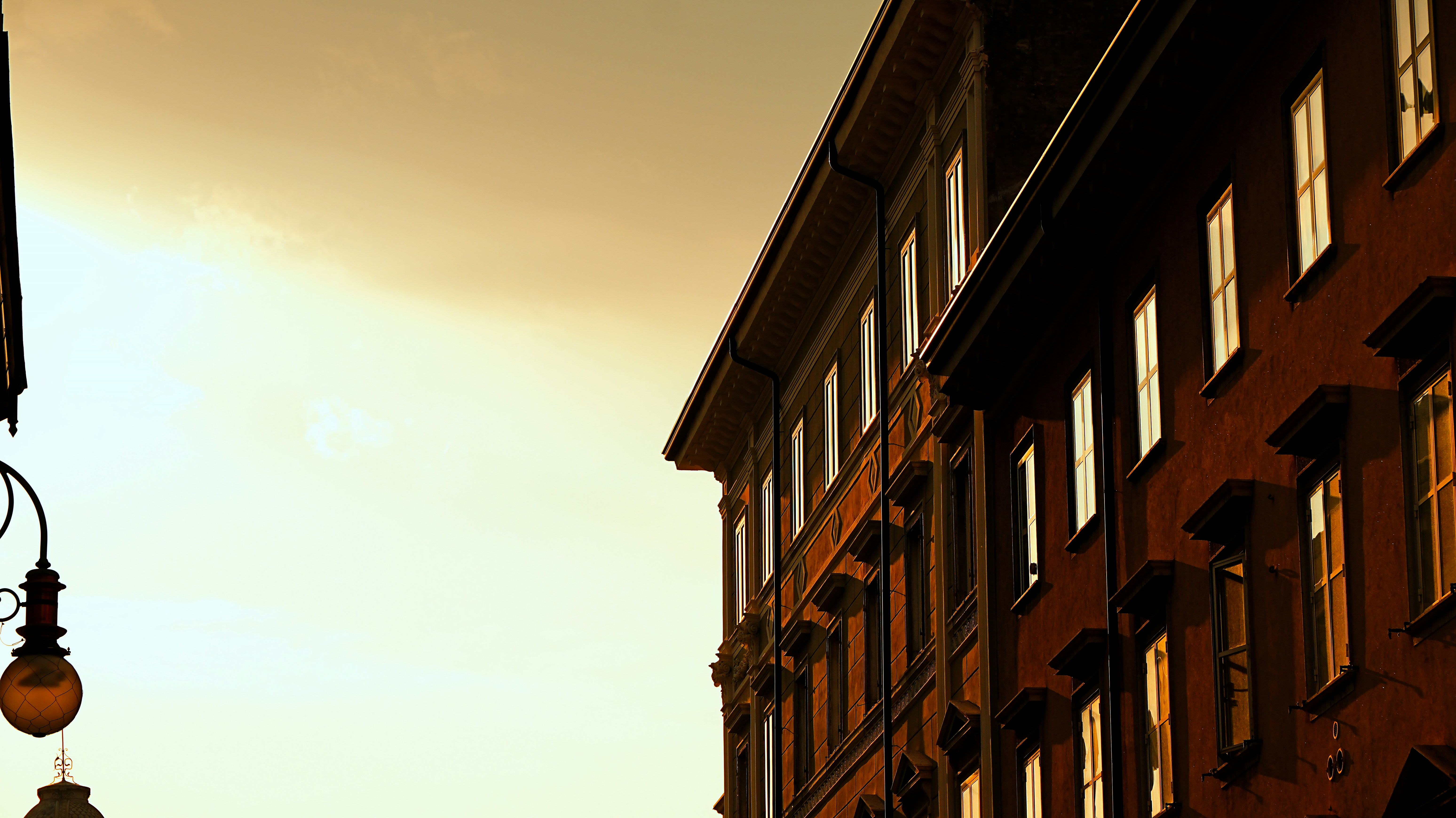 Golden Hour Between Brick Facades: A Quiet Street at Dusk