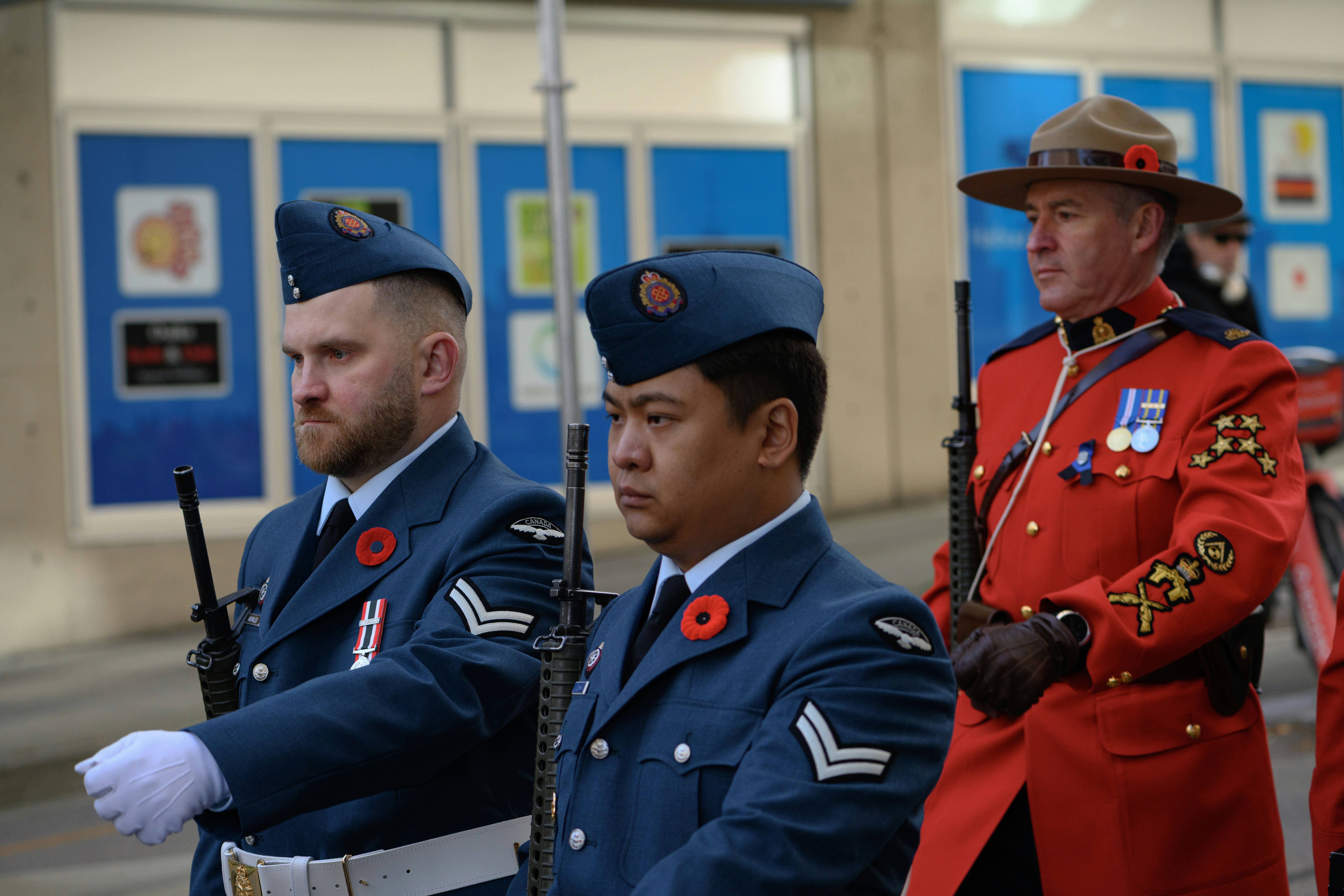 Blue-Uniform Sentinels Lead a Street Parade Under Red Regalia