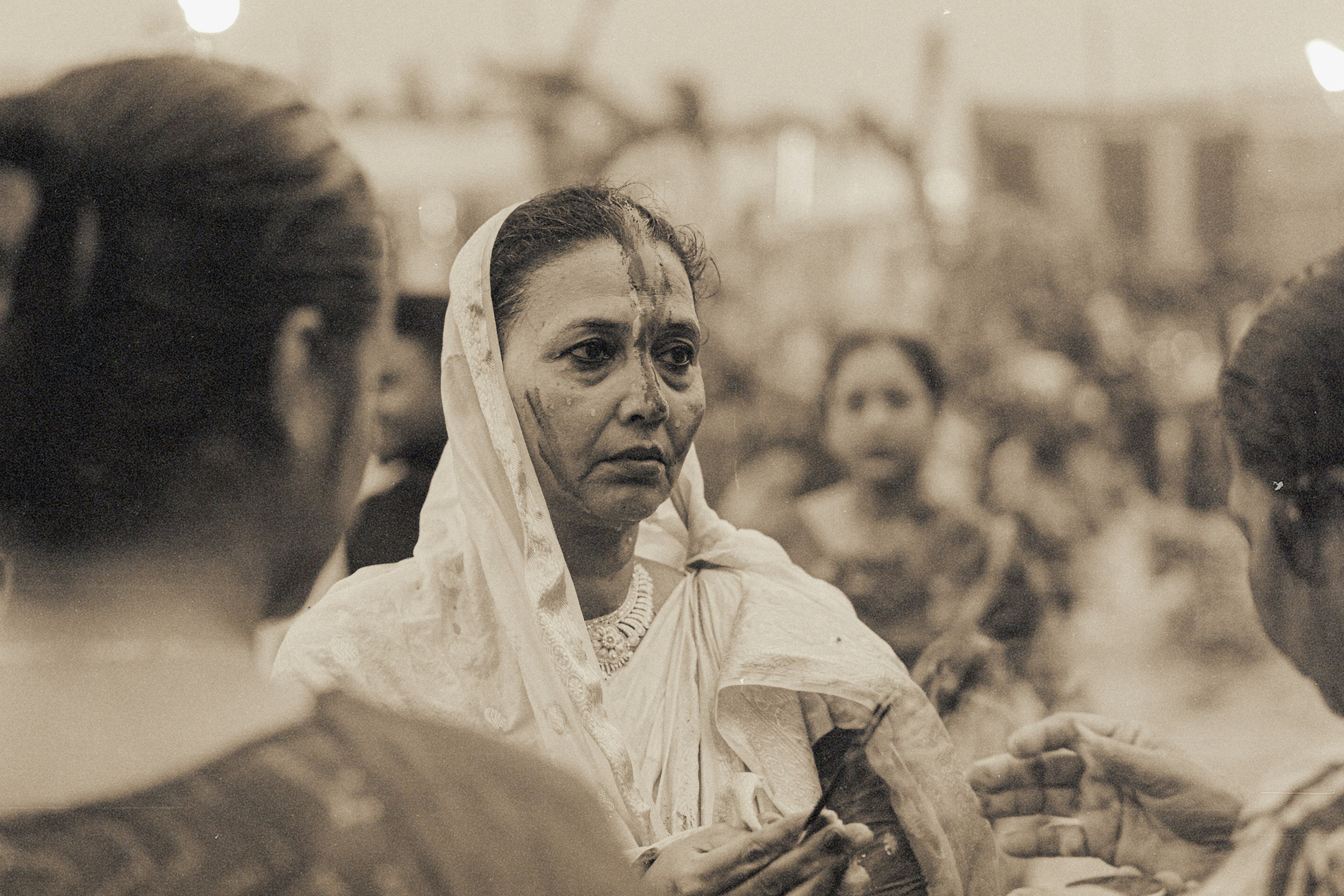 Gaze in Sepia: A Woman in White Among the Crowd