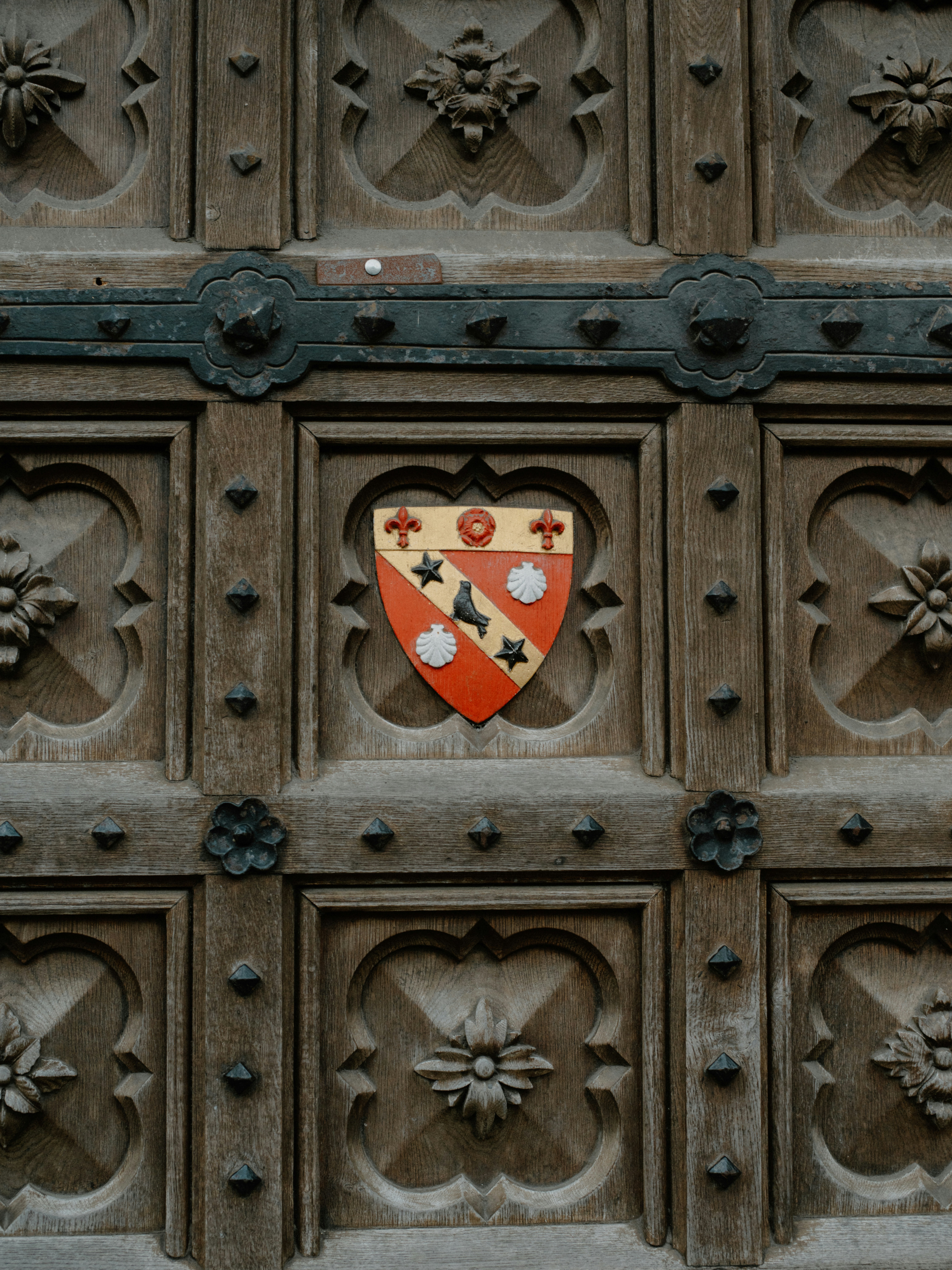 Heraldic Crest Framed by Timeworn Carved Panels