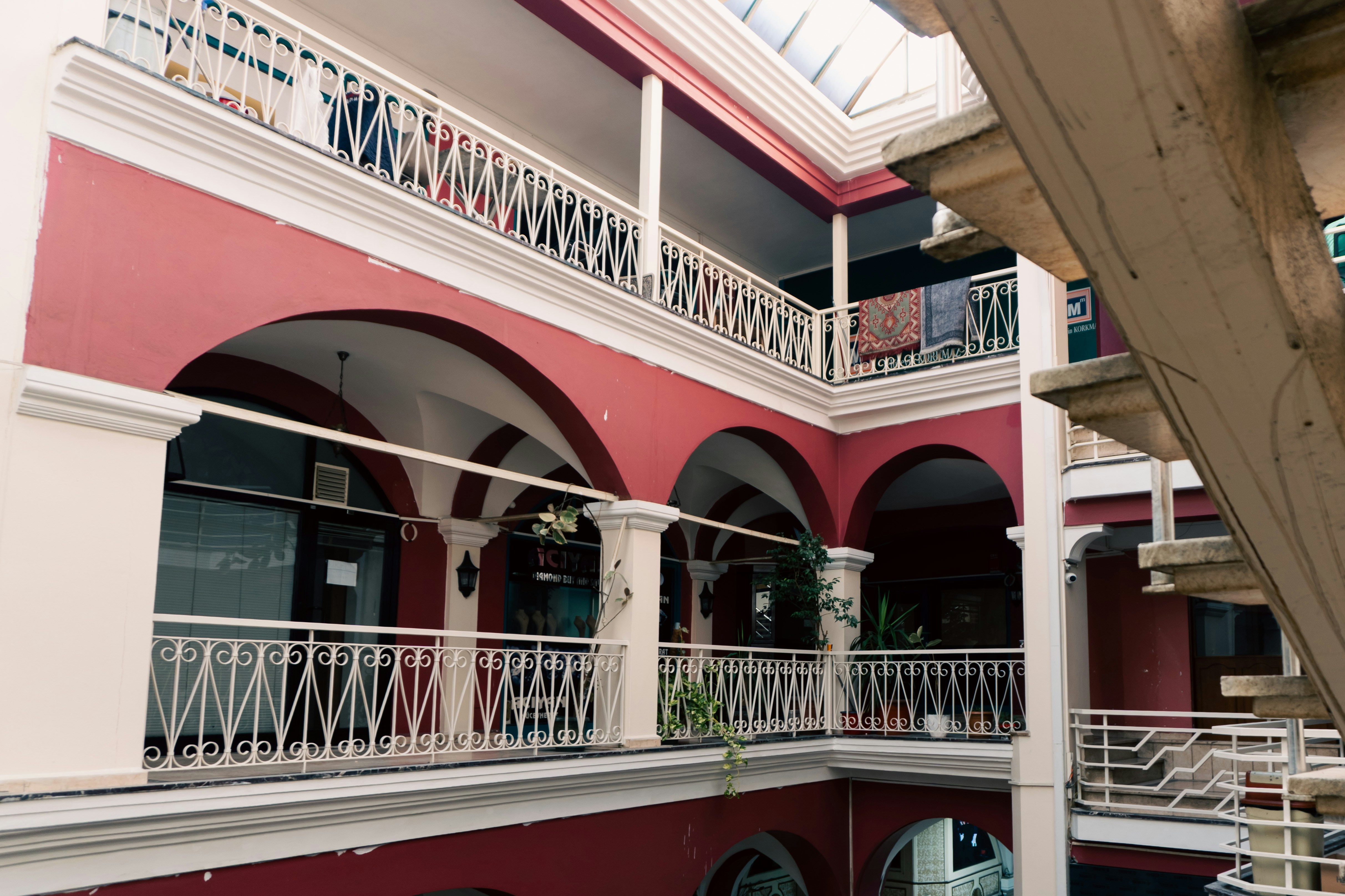 Red Archways and White Rails: An Atrium of Quiet Geometry
