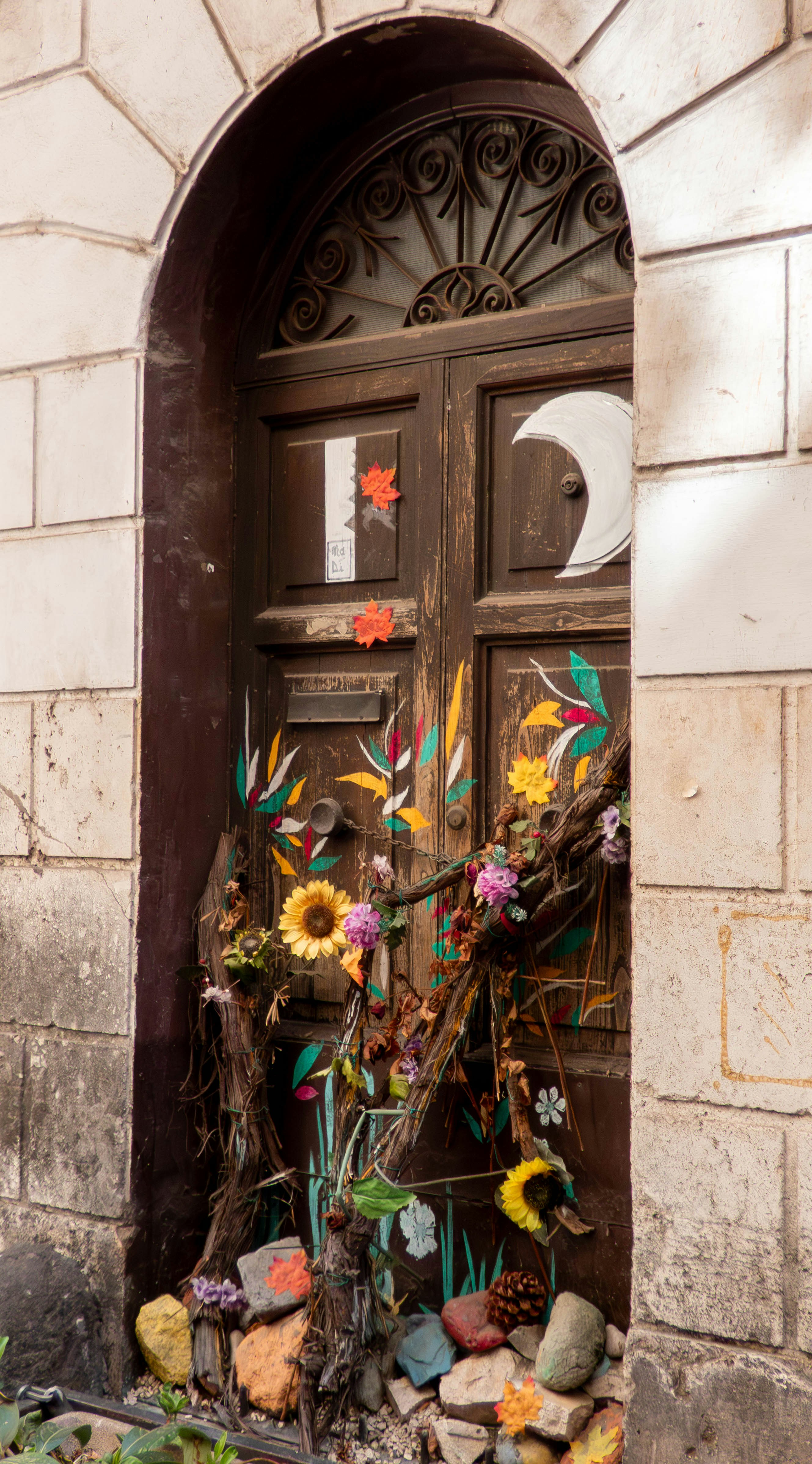 Threshold of Color: Painted Leaves and Sunflowers Framing a Rustic Door