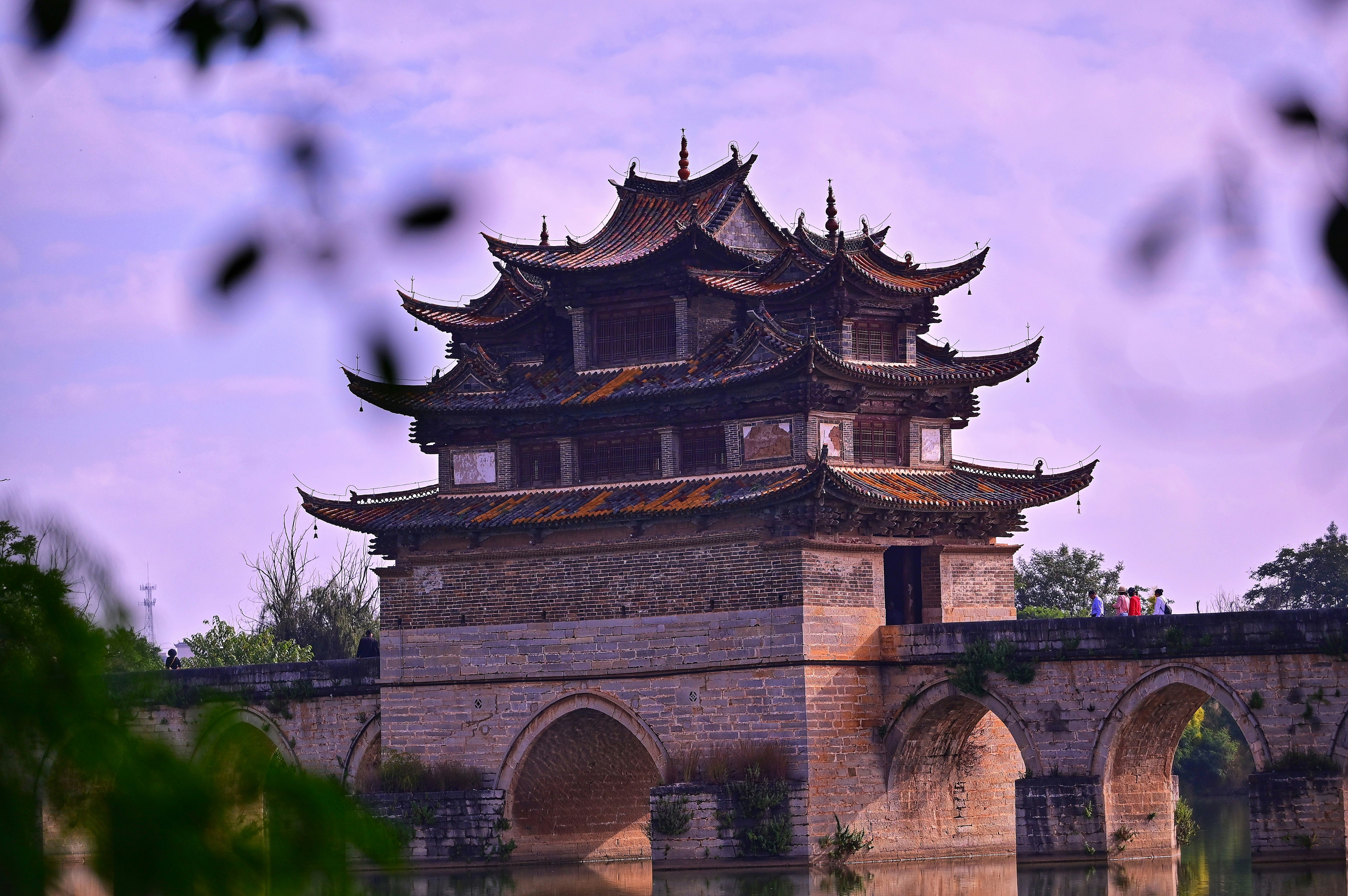 Crown of Curves: A Pagoda Rising Over a Stone-Arch Bridge