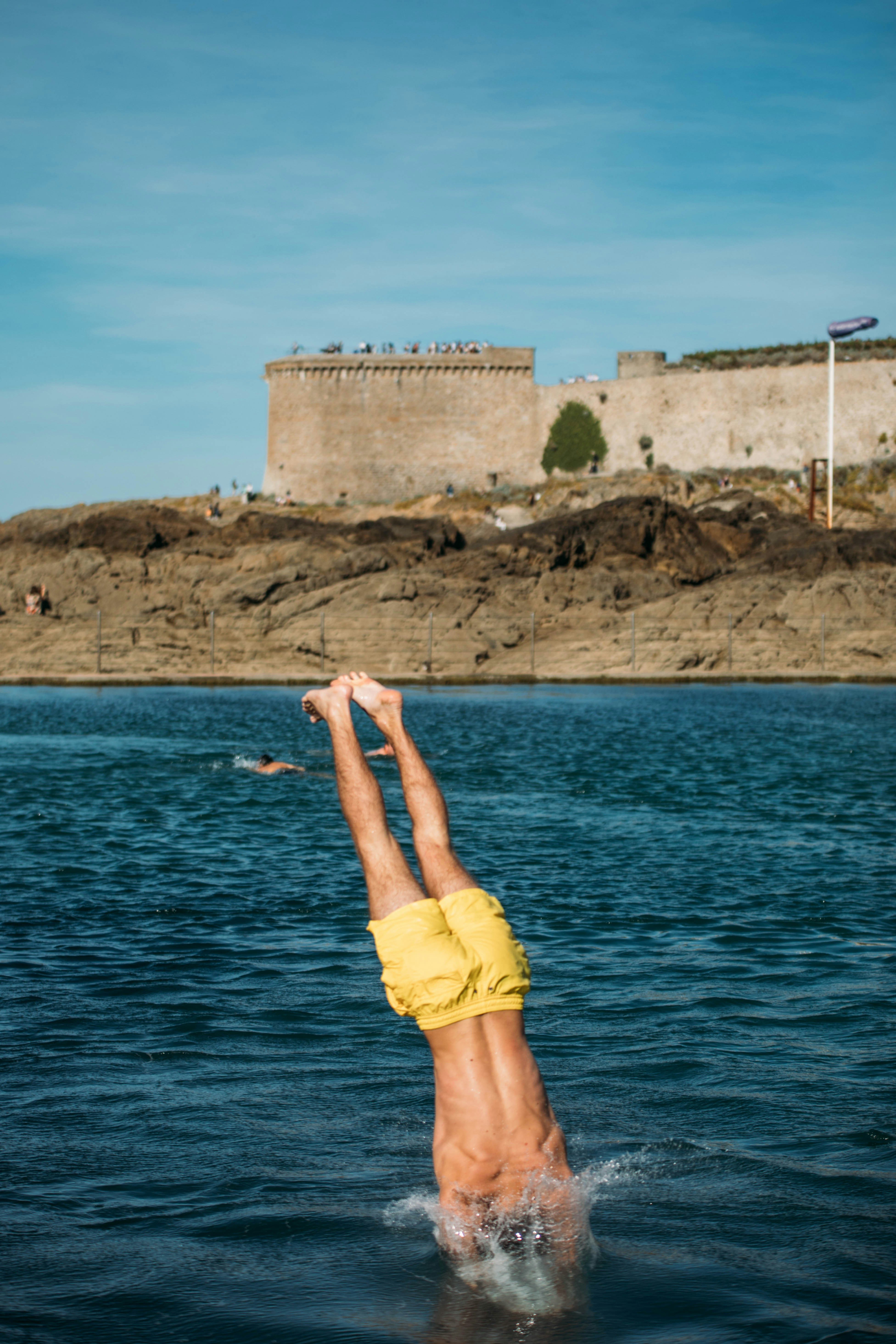 Vertical Inversion by the Blue Shore: Handstand beside a historic fortress