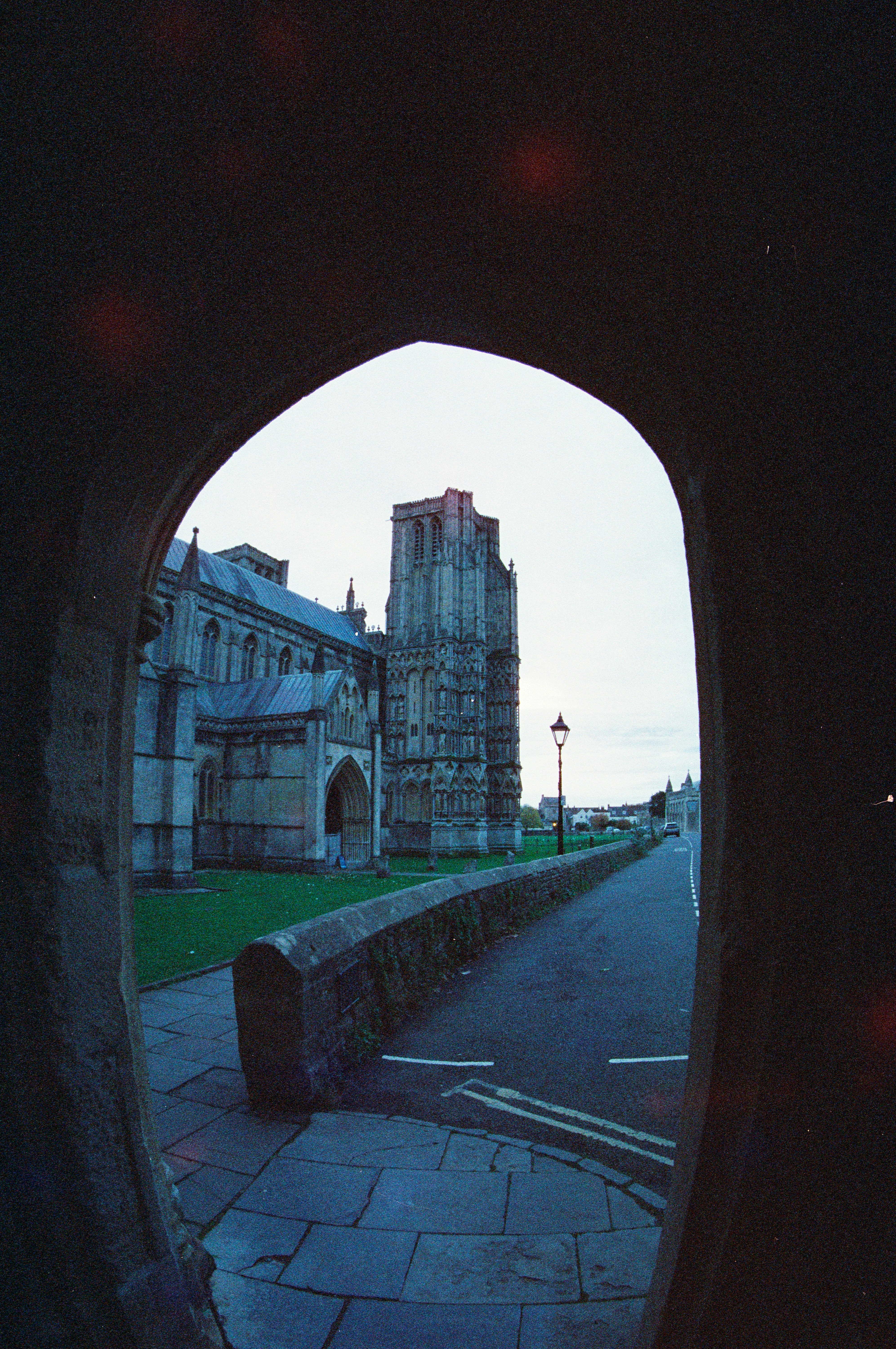 Archway Vista: A Gothic Tower Framed by a Quiet Cloister