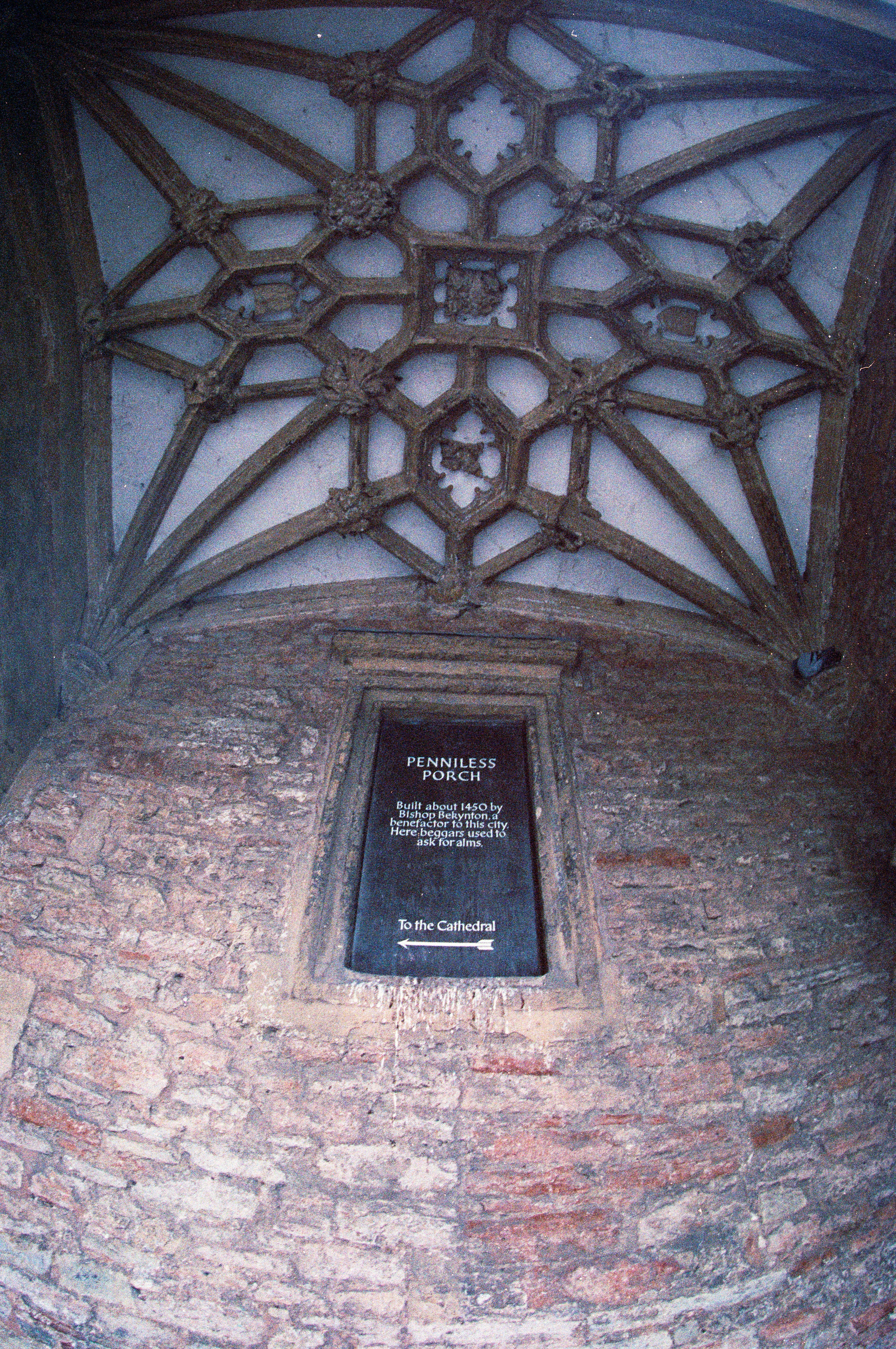 Stone building with ornate ceiling and plaque.
