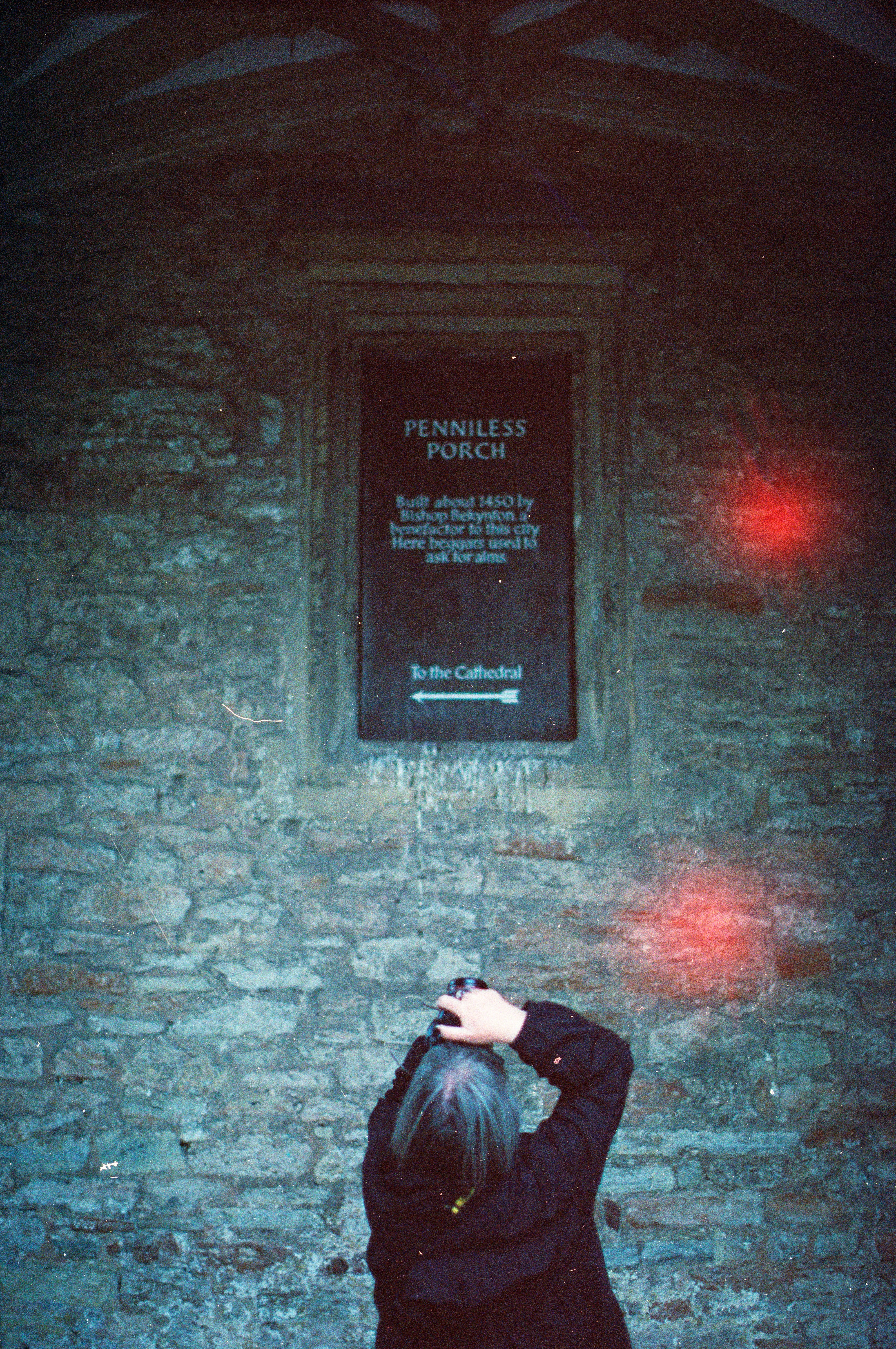 Penniless Porch: A Framed Sign in a Damp Stone Corridor