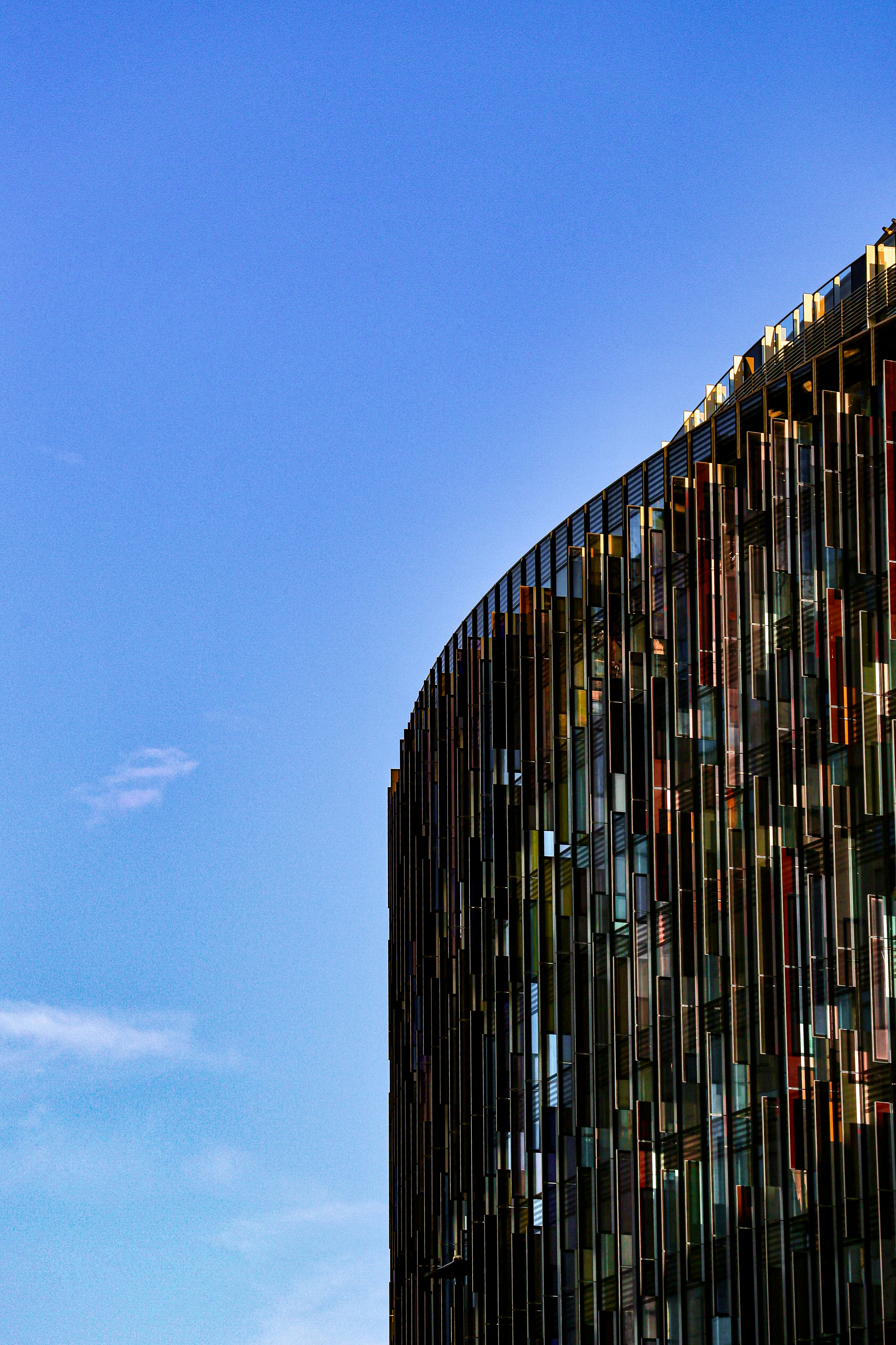 Prismatic Curve: Glass Curtain Bending Toward the Sky