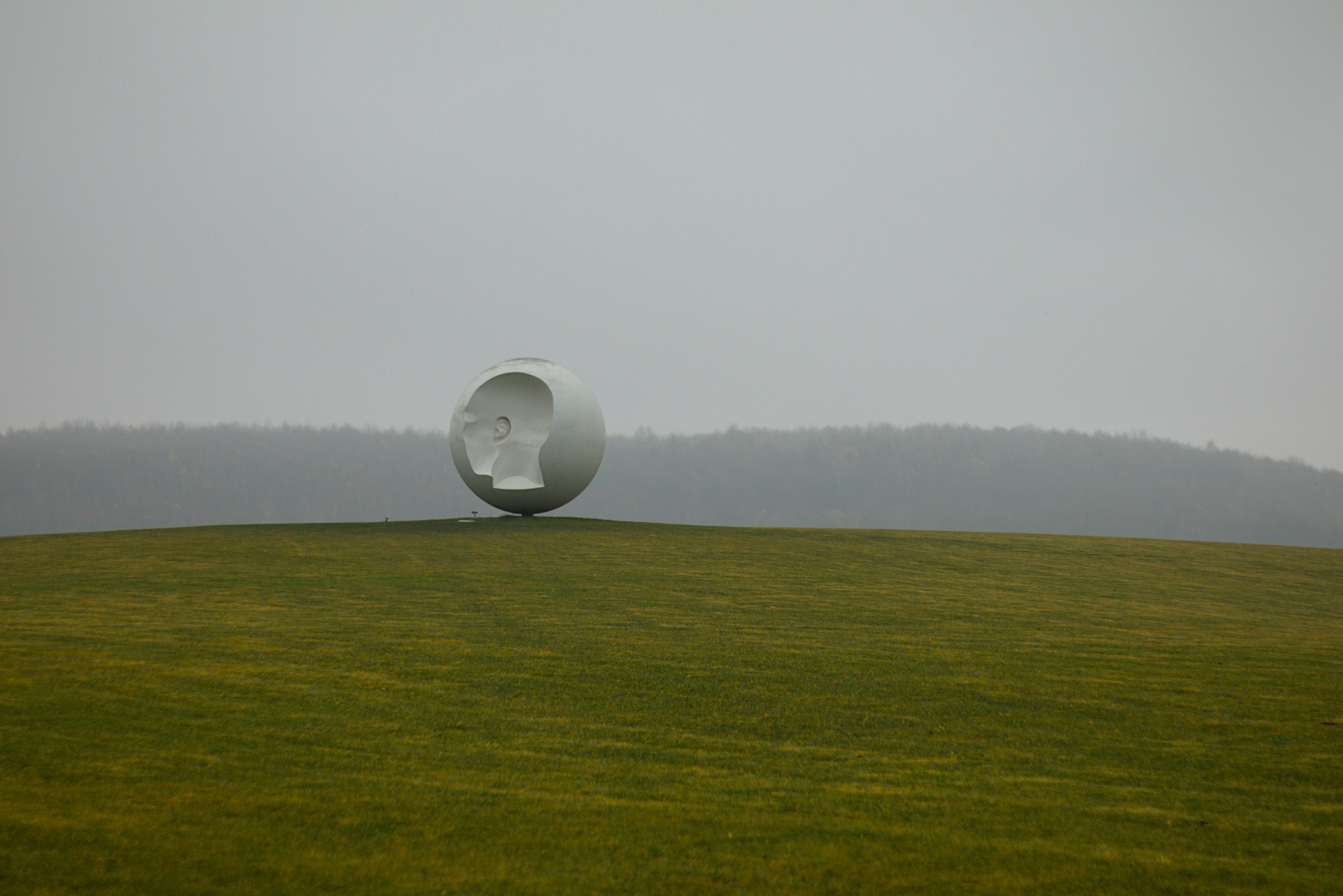Solitary Orb on a Crest: A Quiet Hilltop Sculpture