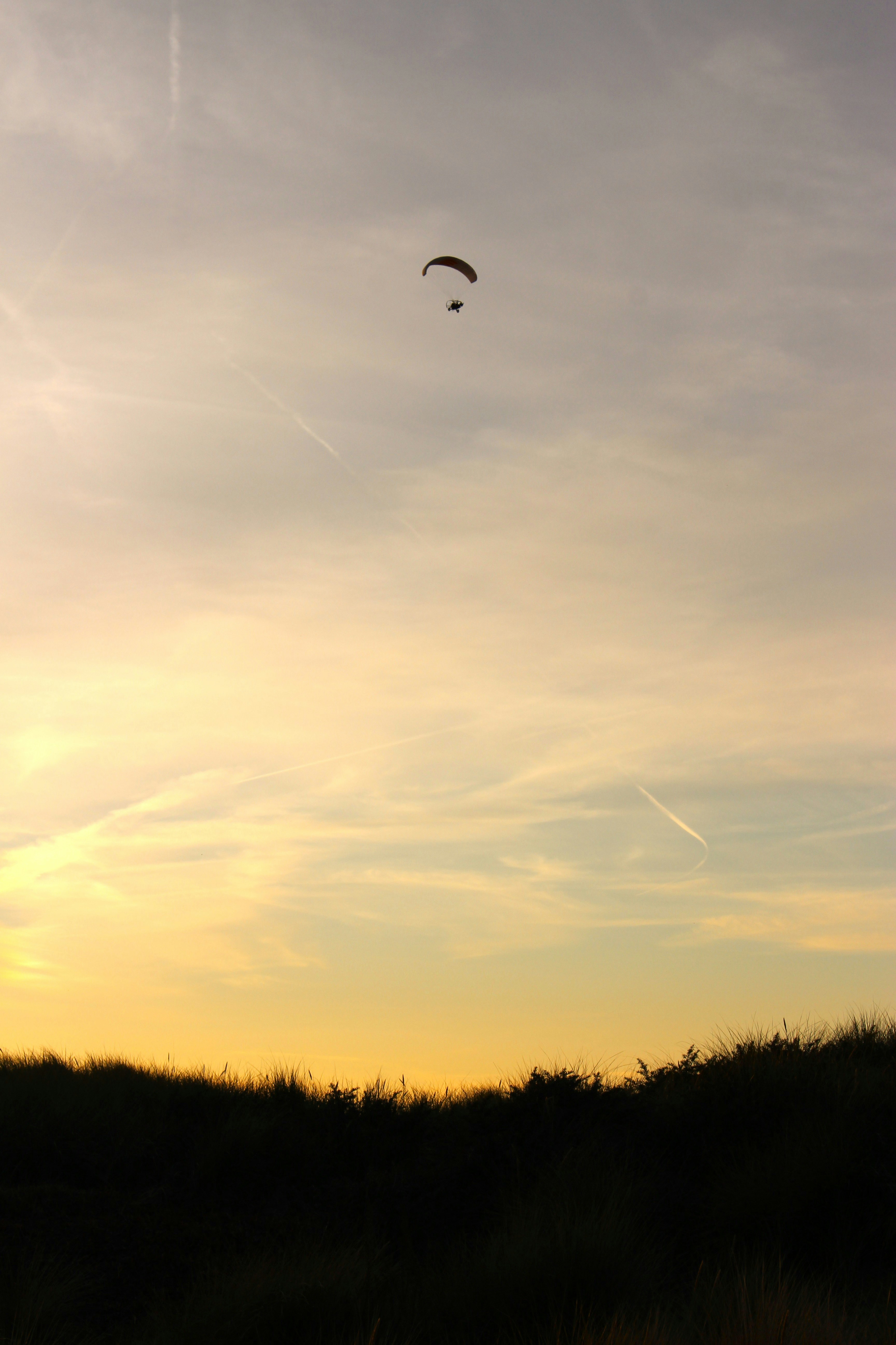 Dusk Paraglider Over Quiet Dune Horizon