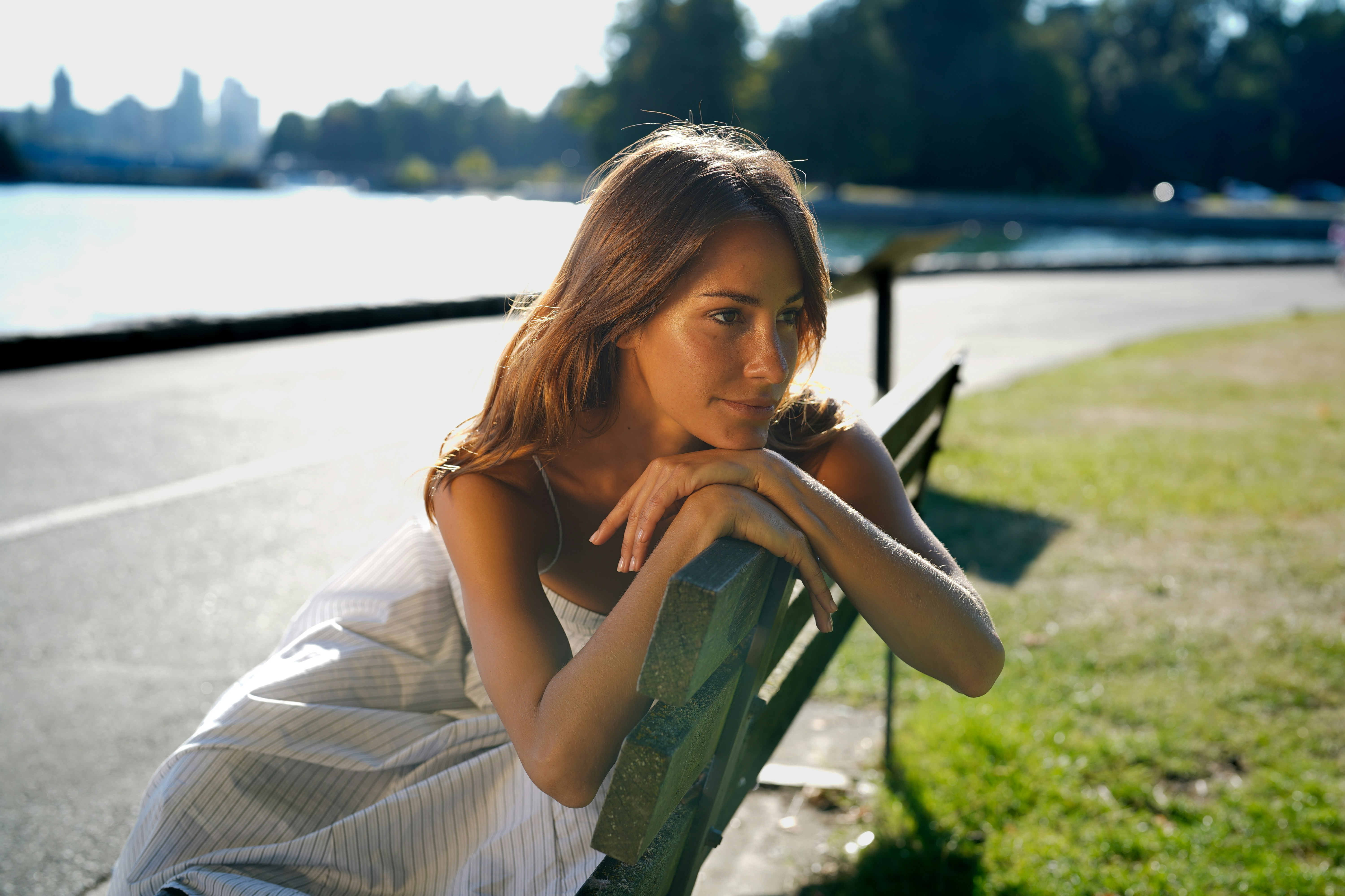 Beautiful model sitting on park bench in Vancouver, BC Canada.