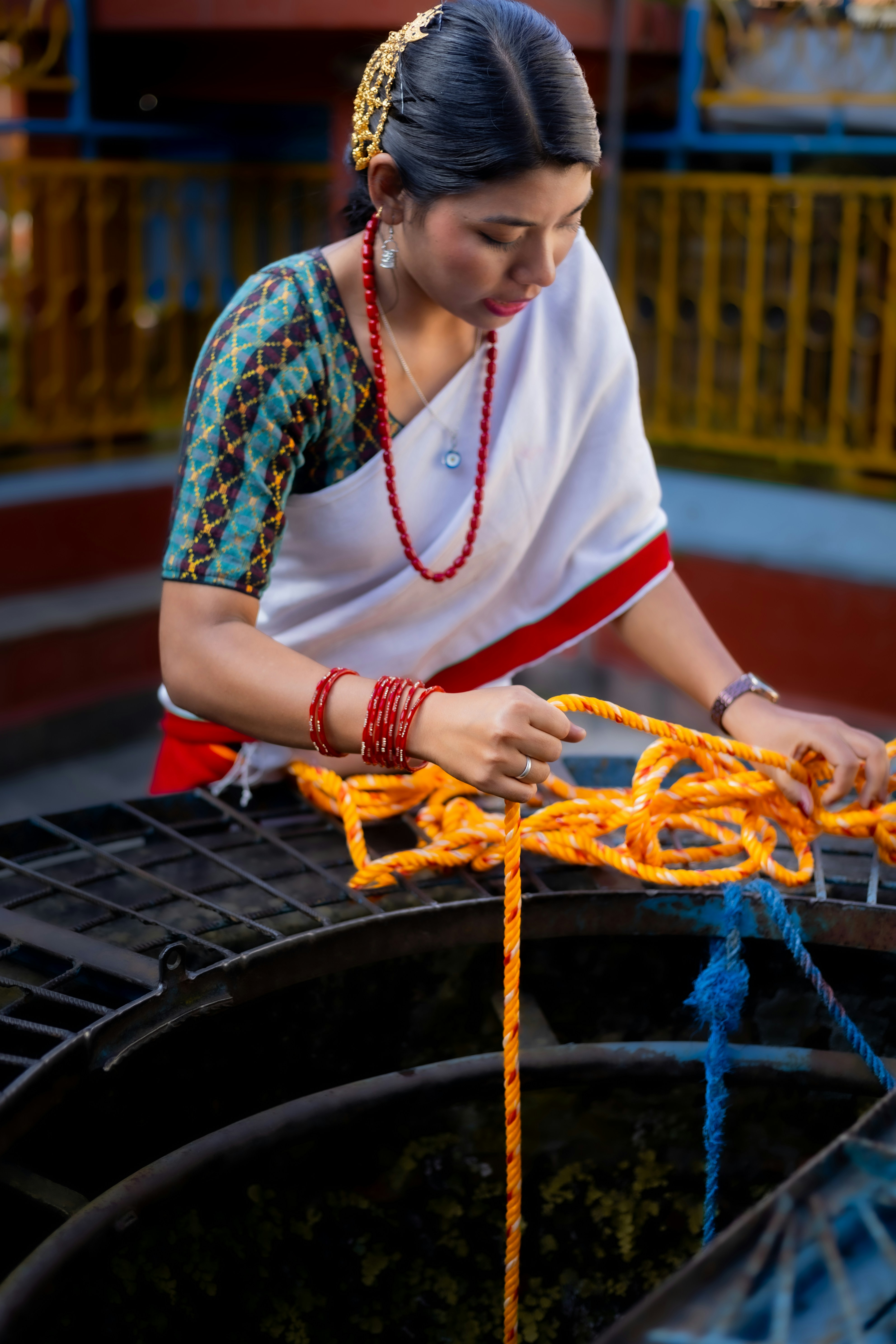 Rope Craft by the Well: A Traditional Attire Weaver at Work
