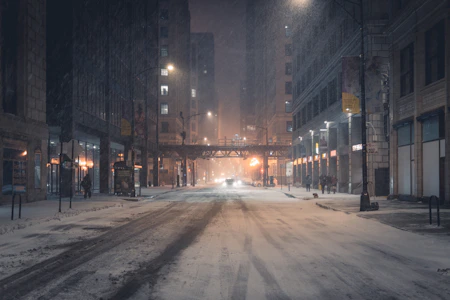 Vanishing Point in Snow: An Empty City Street Embraced by Neon Glow