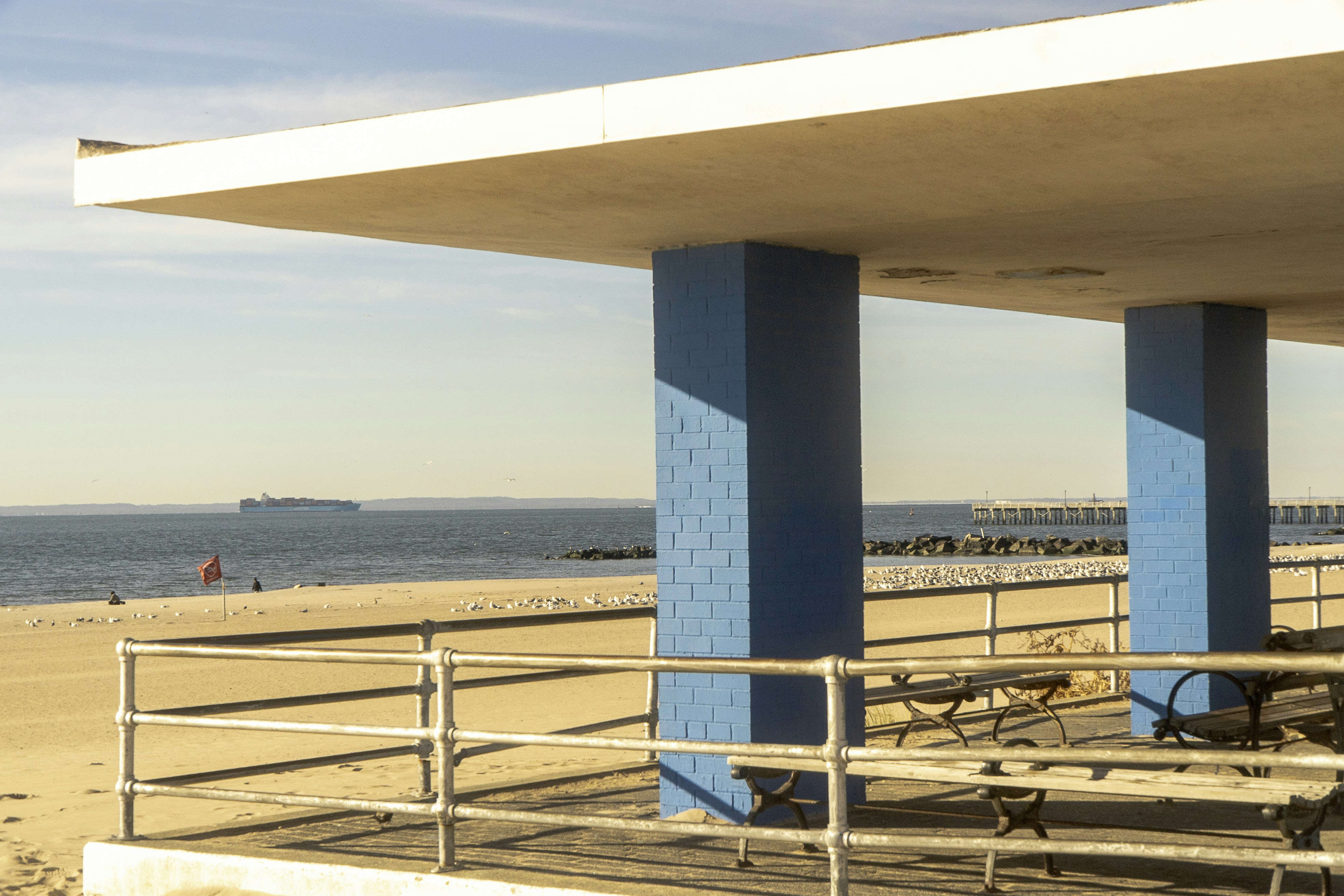 Blue Pillars Framing a Quiet Beachfront Shelter
