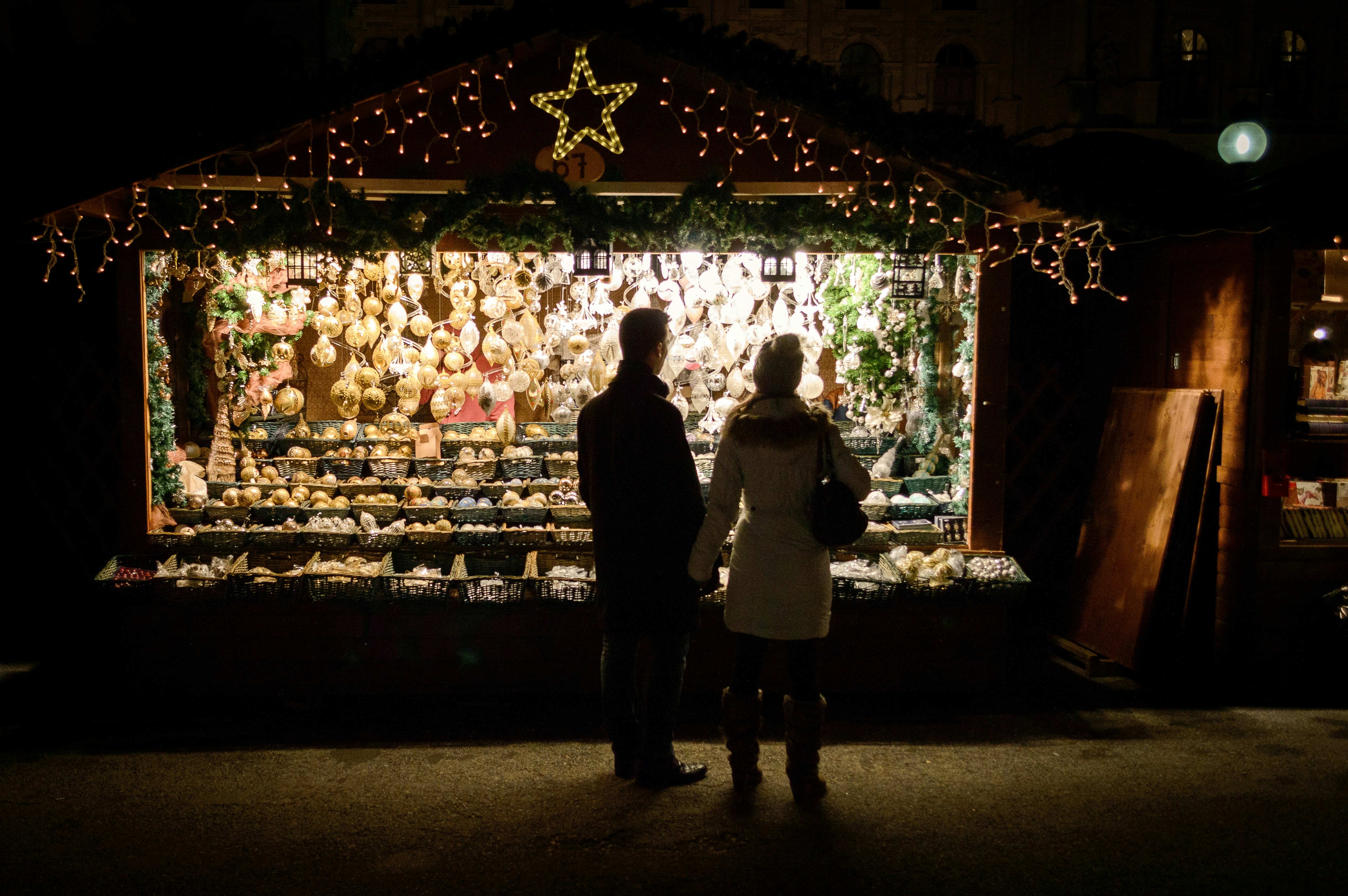 Midnight Market Glow: Silhouettes Before a Christmas Ornament Stall