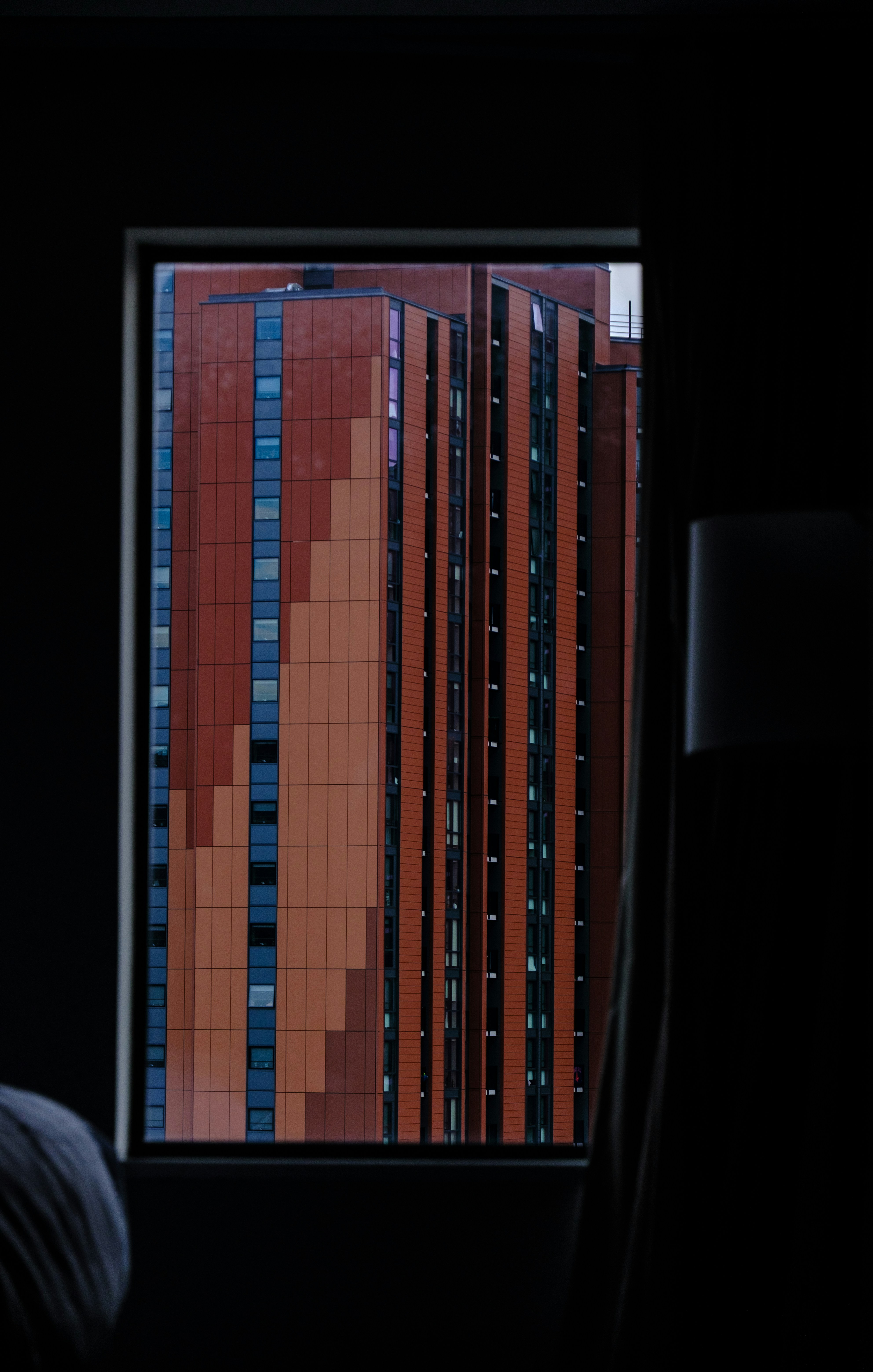 Vertical Rust: A City Block Framed in a Dark Room