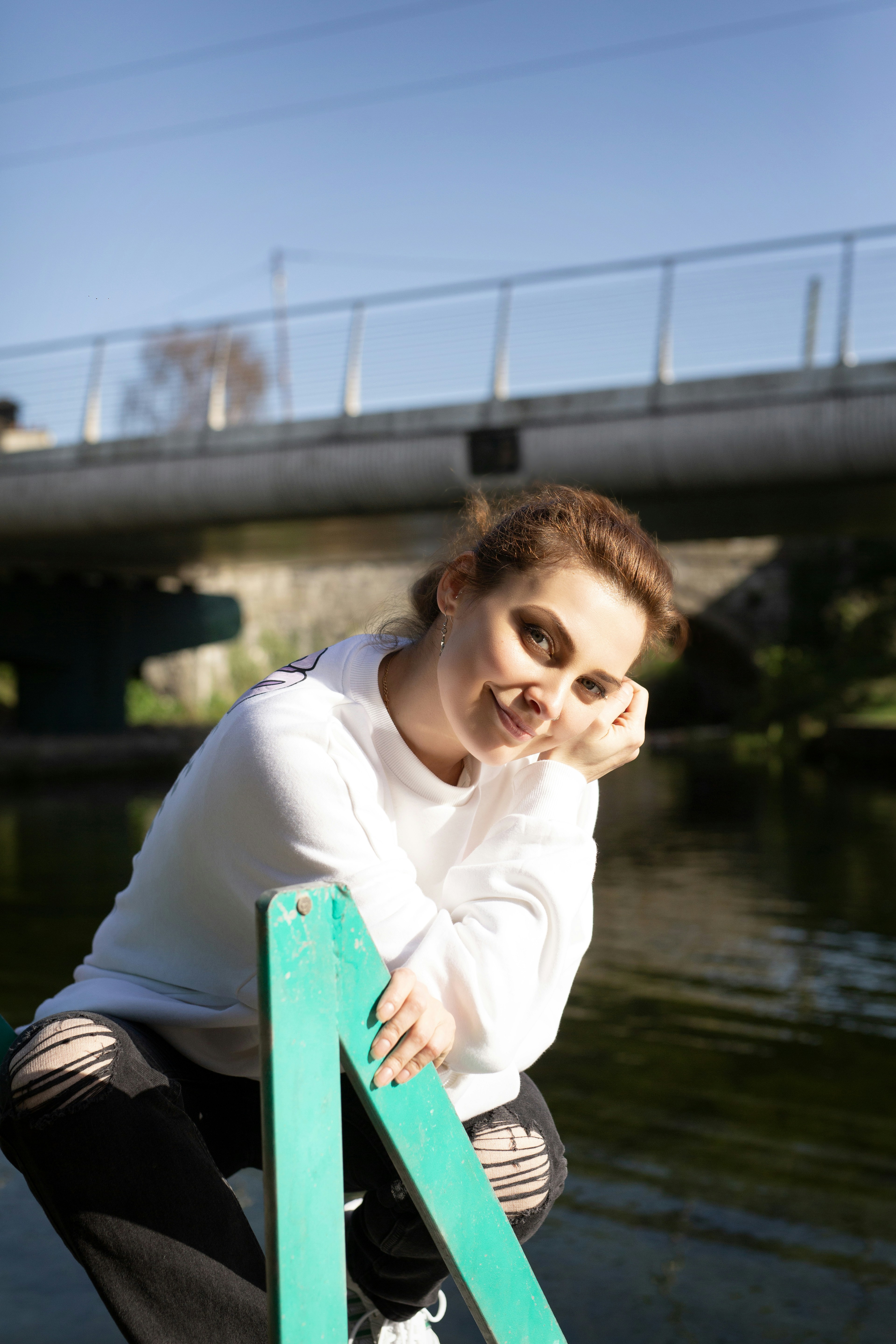 Sunlit Smiles by the Turquoise Rail Under the Bridge