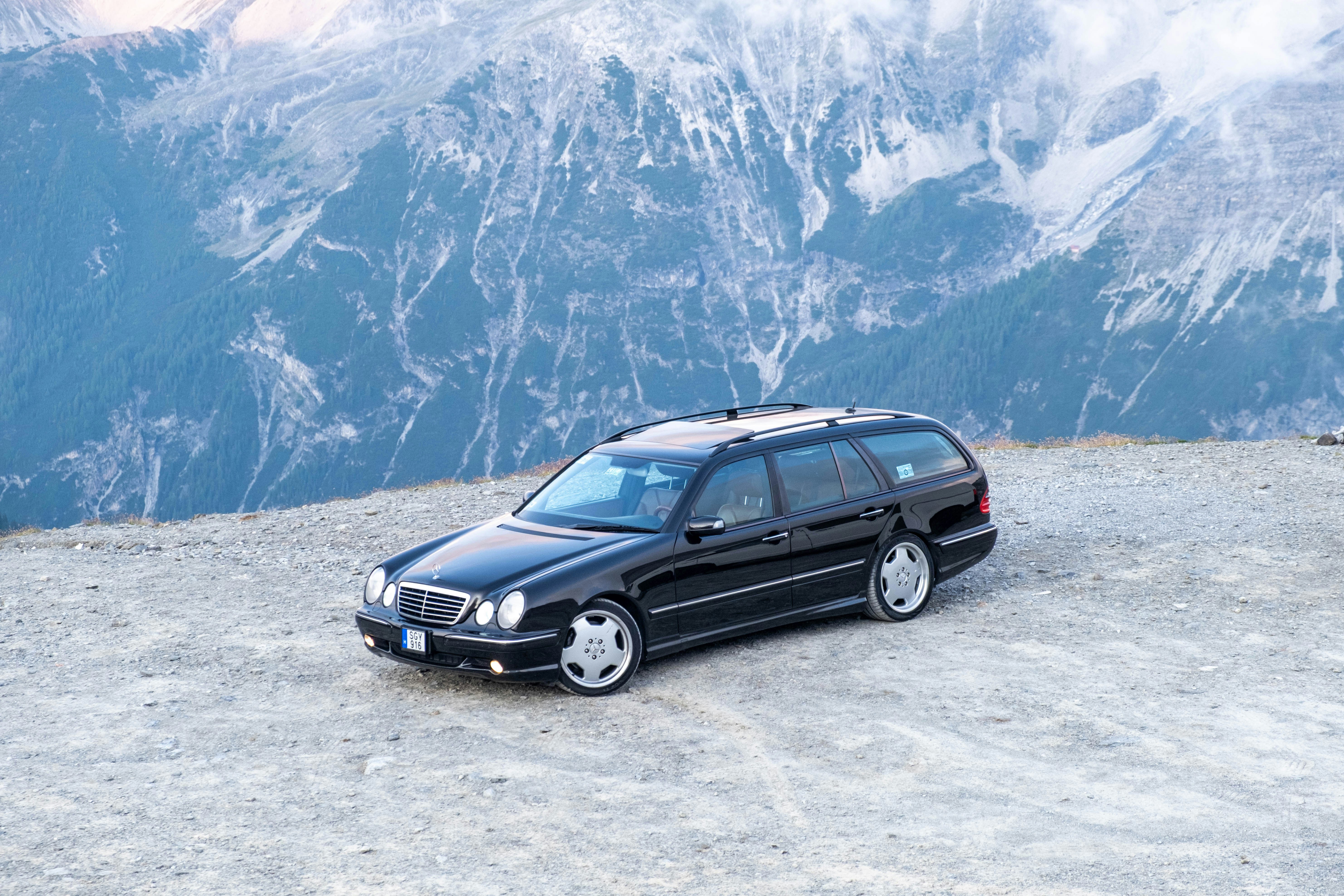 Black station wagon parked on a mountain overlook. photo – Free Travel ...