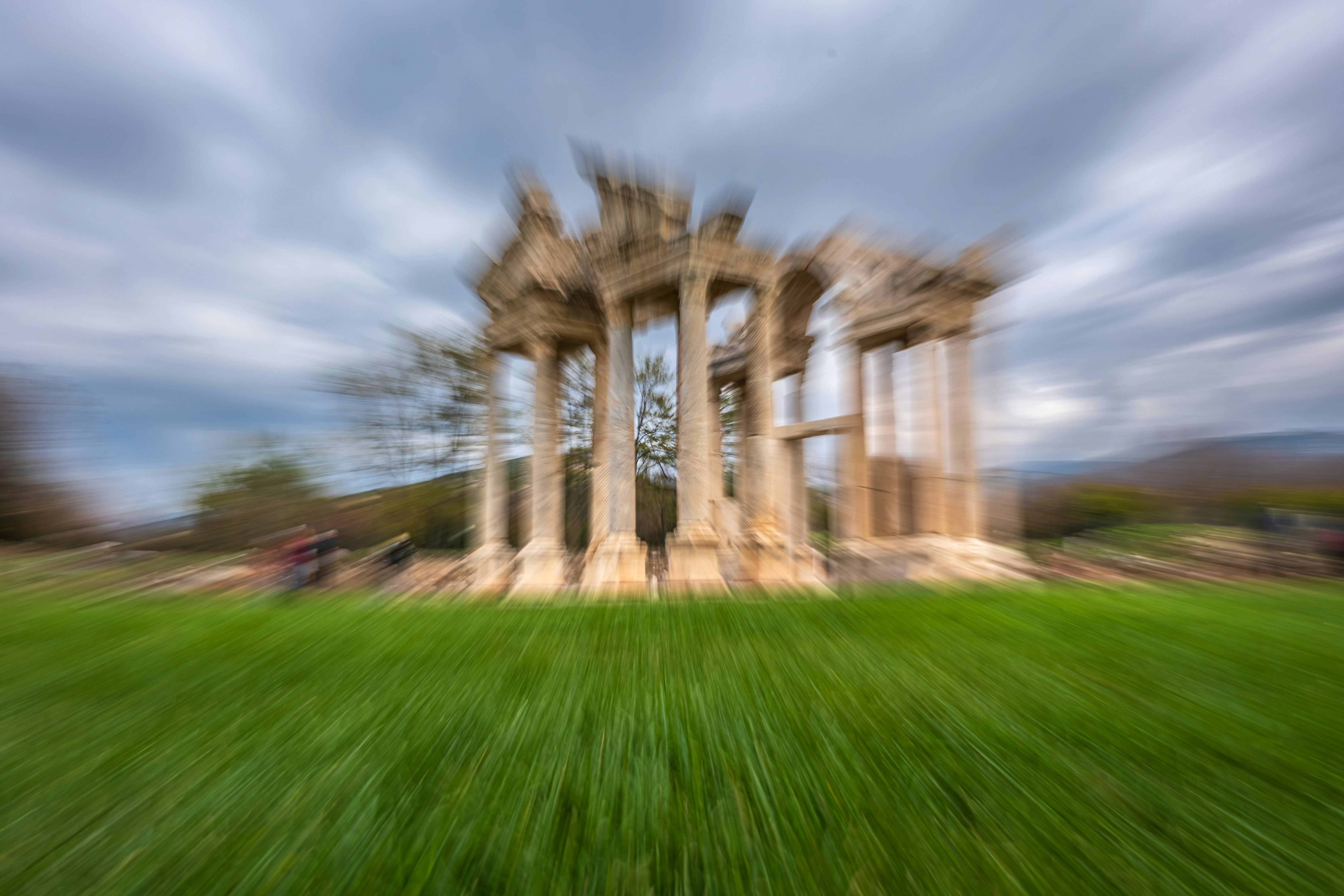 Time-Warped Temple: Central Columns Surrounded by a Swirl of Grass and Sky