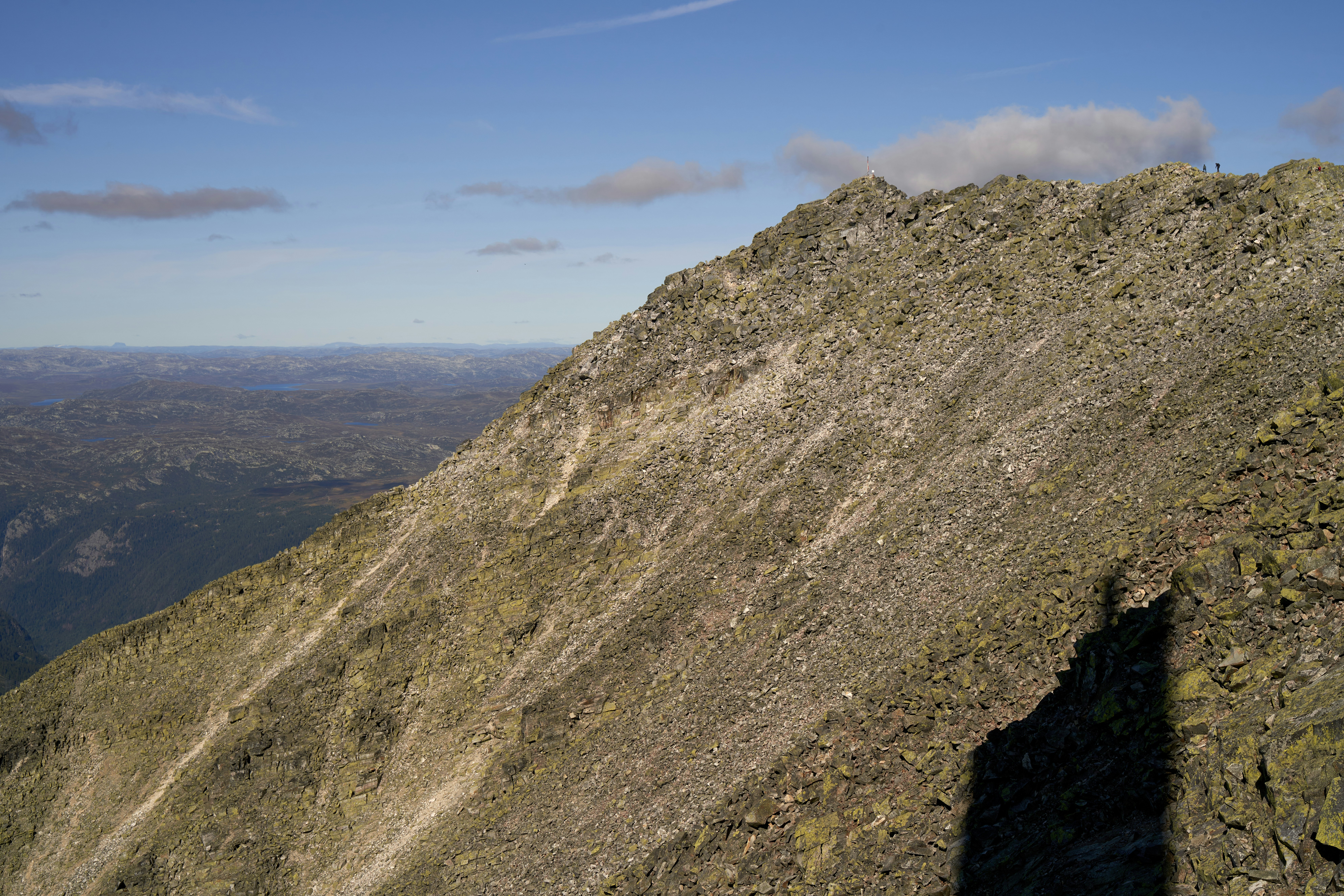 Hikers on the top of the Gaustatoppen mountain with amazing view, one of the highest and most beautiful mountain in Norway