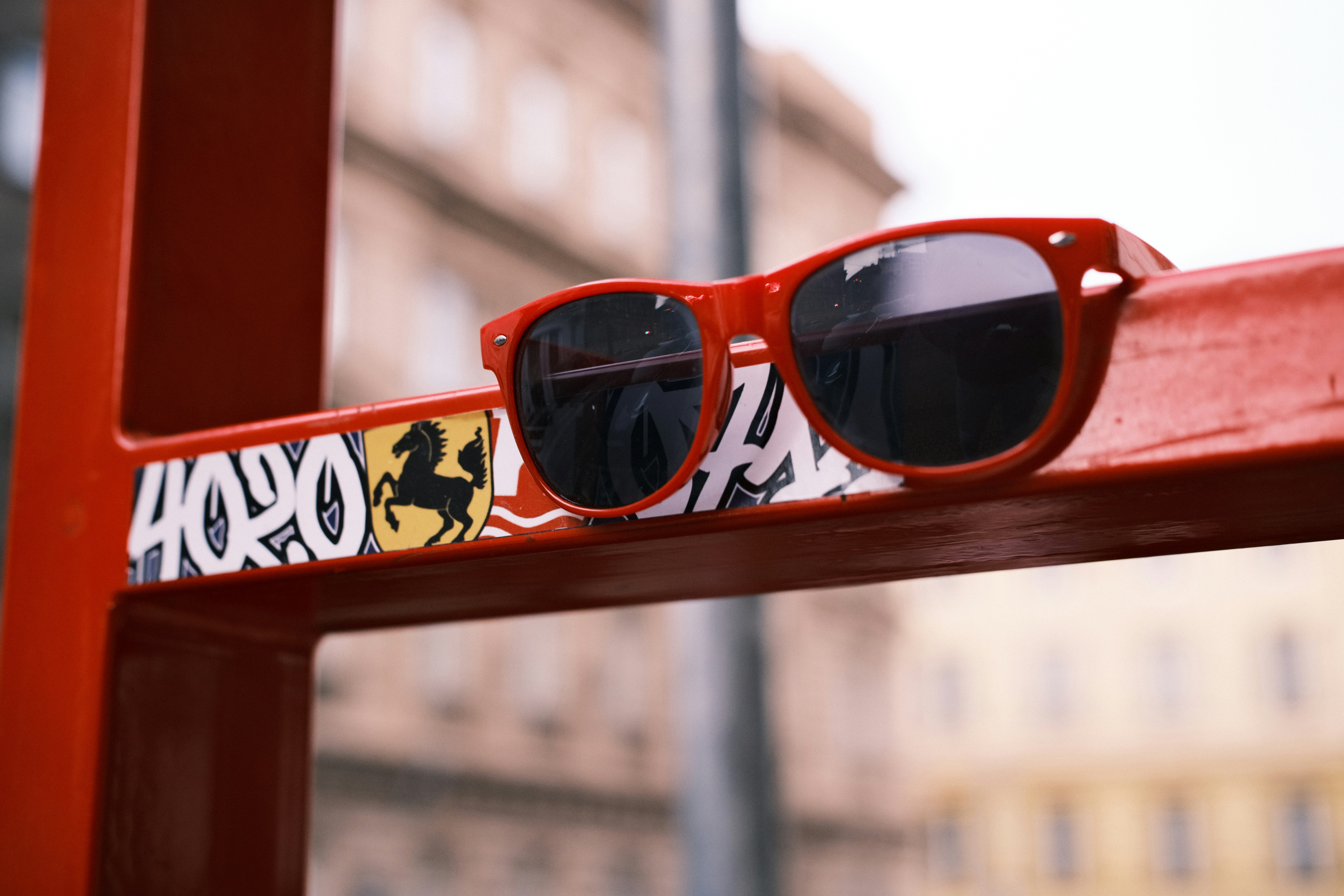Crimson Frames on a Red Rail: A Quiet Street-Color Moment