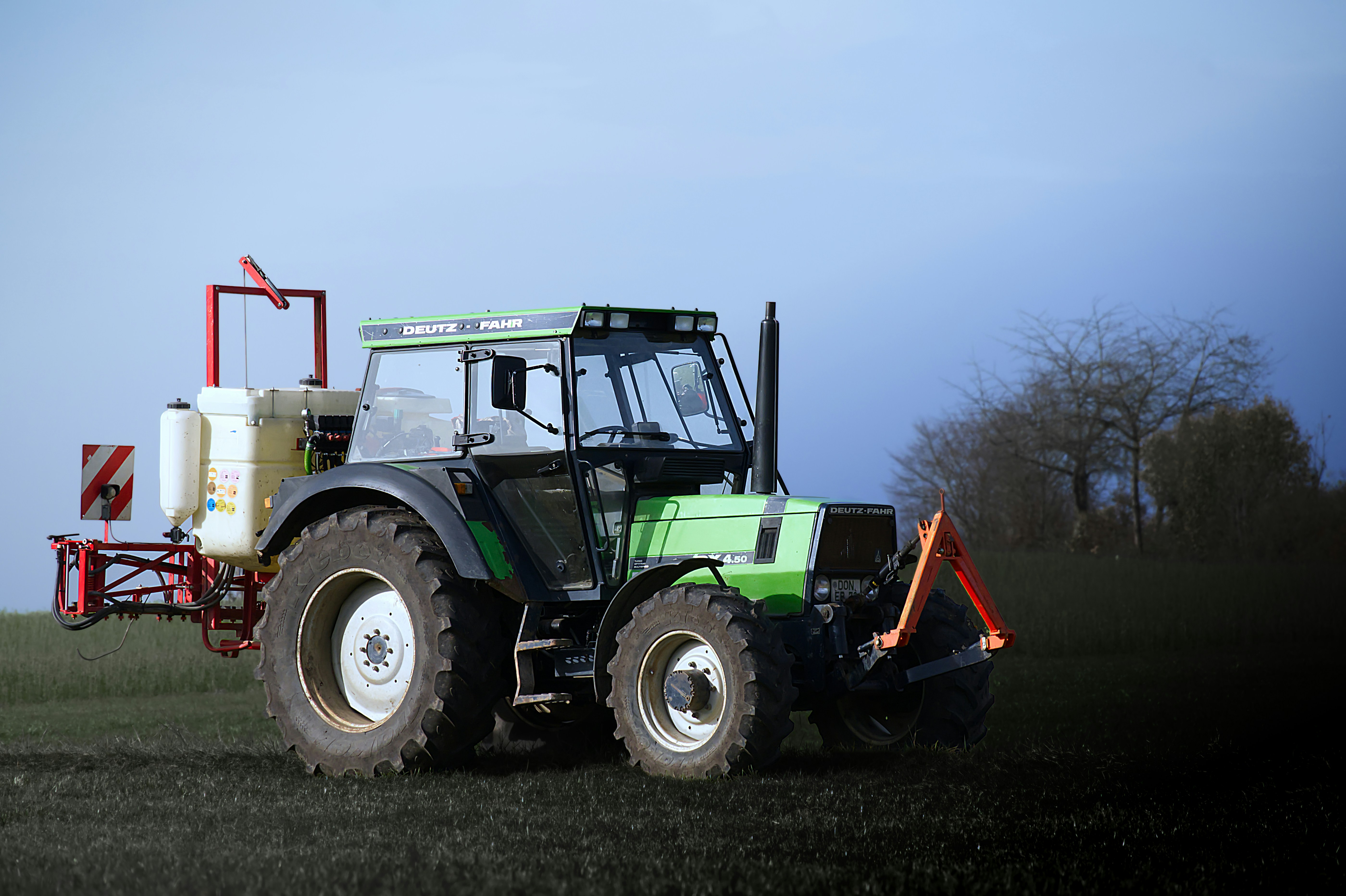 A fendt tractor stands still on a green field.