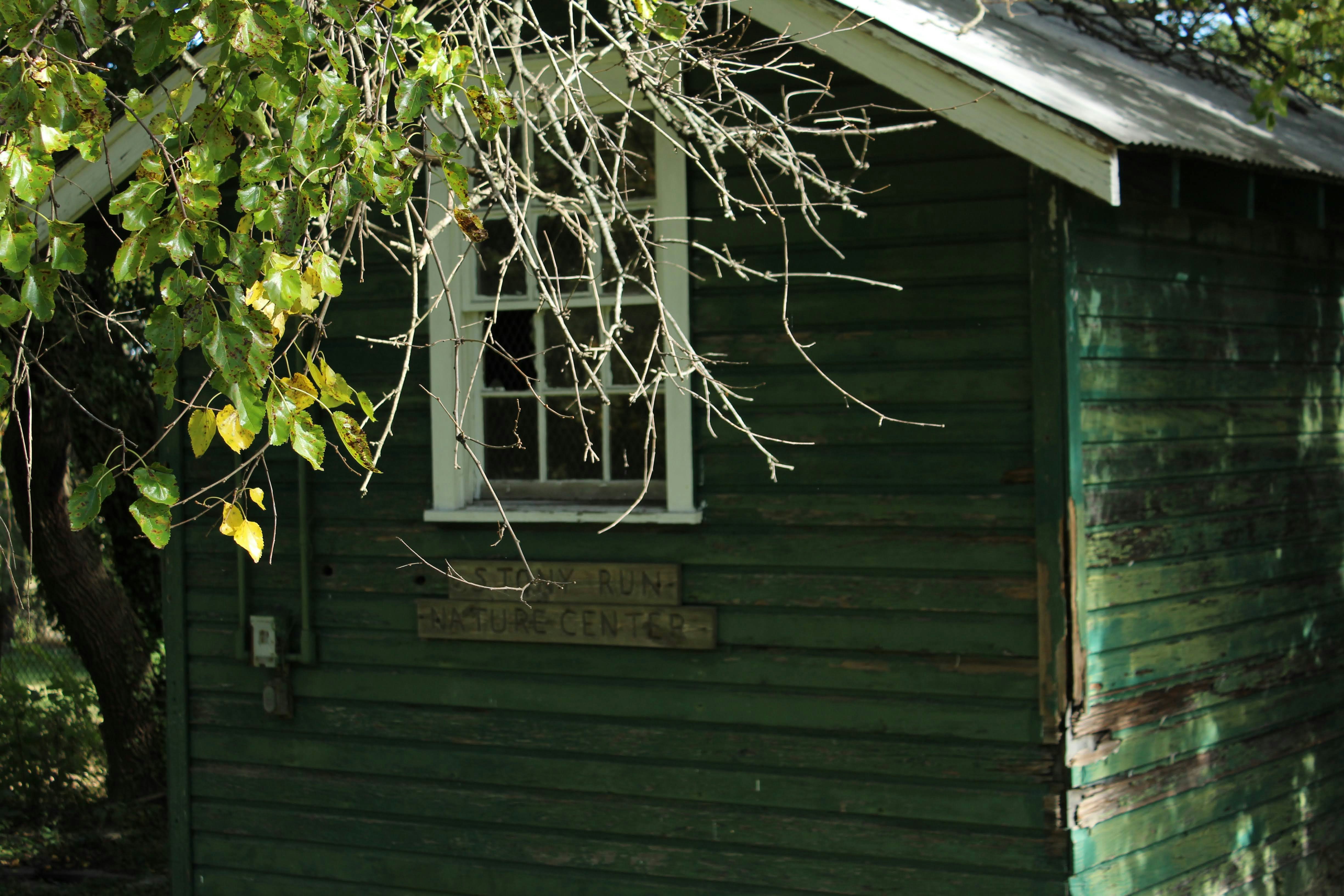 A simple, rustic wooden sign pointing the way to the Stony Run Nature Preserve within Bellevue State Park. A quiet reminder to step off the beaten path and explore the preserved woodlands.