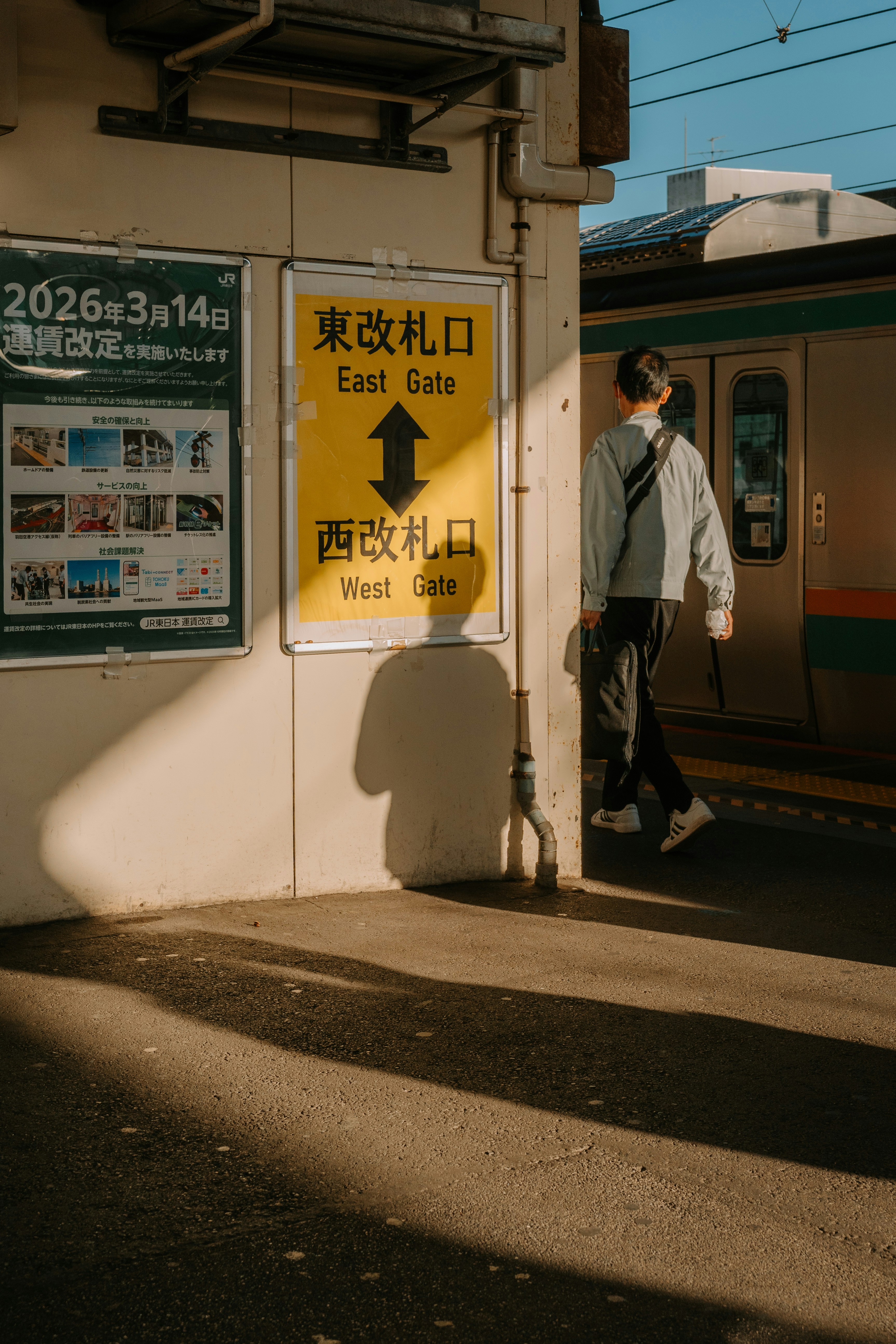 Threshold in the Golden Hour: Commuter stepping toward the East Gate