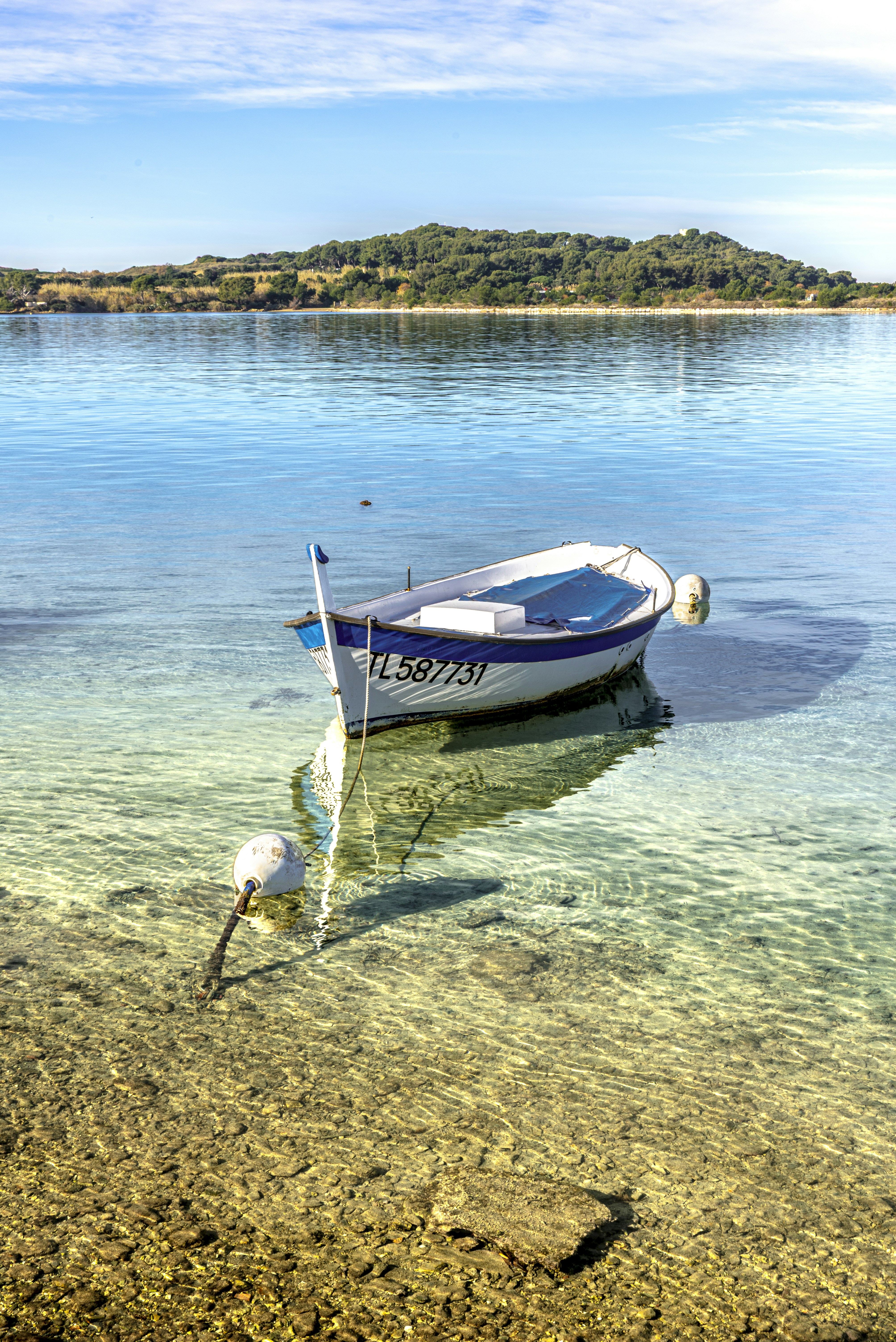 Azure Quiet: A Lone Boat Anchored in Crystal Coastal Waters