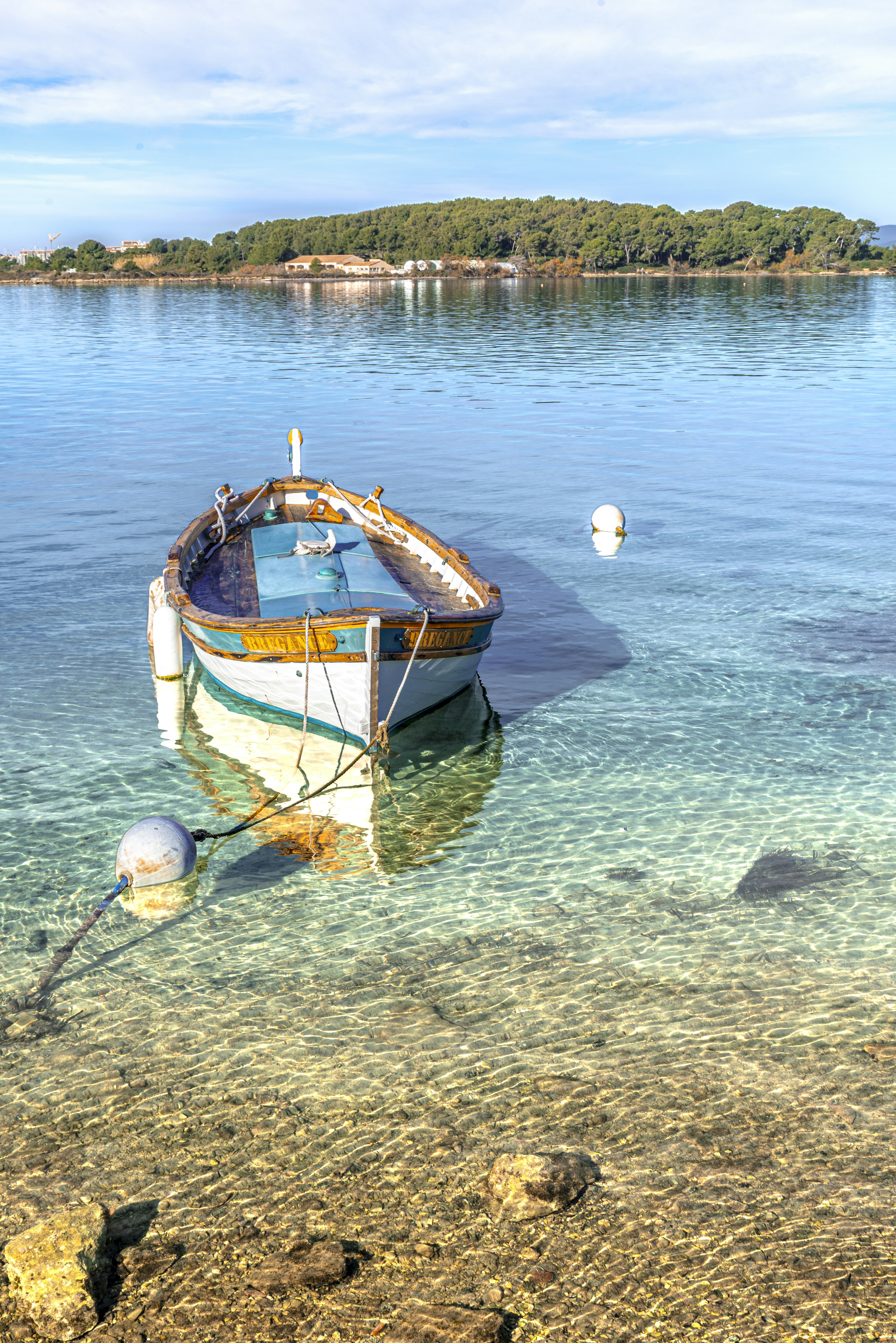 Turquoise Harbor: A Small Boat Anchored in Crystal Water