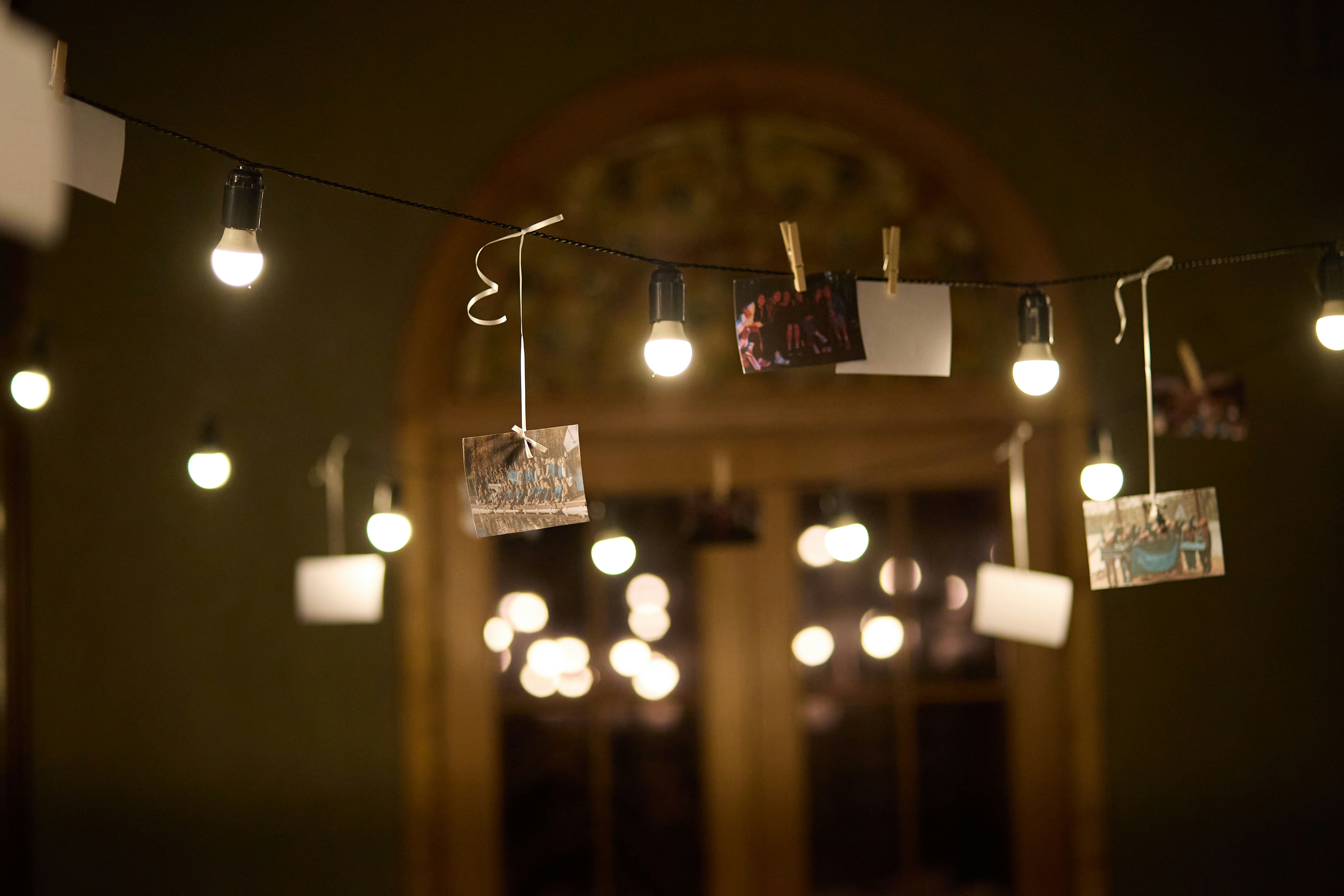 Hanging Lightlines: A Corridor of Photographs Under Soft Orbs
