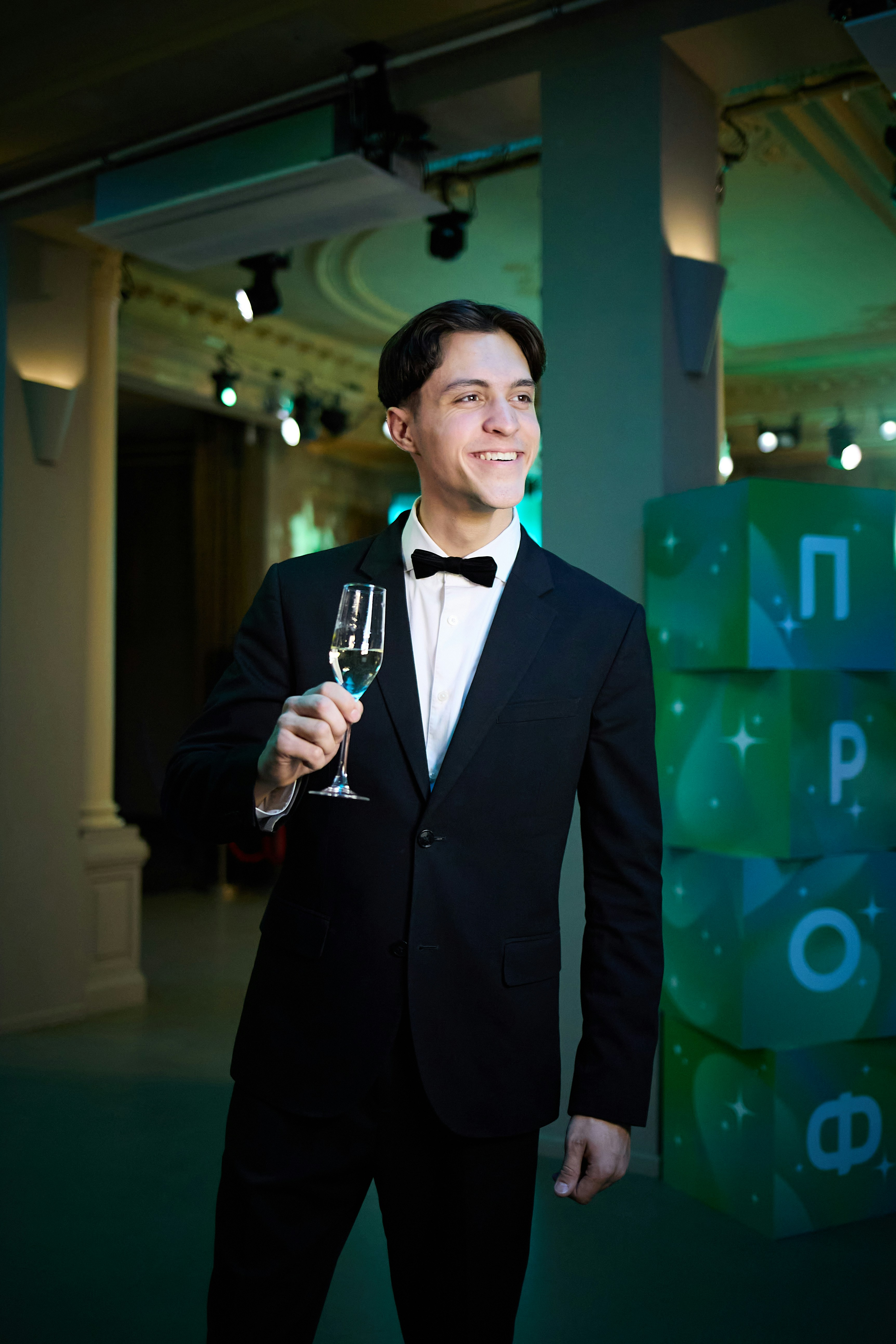 Toast Under Neon Lights: A Dapper Host in a Black-Tie Moment