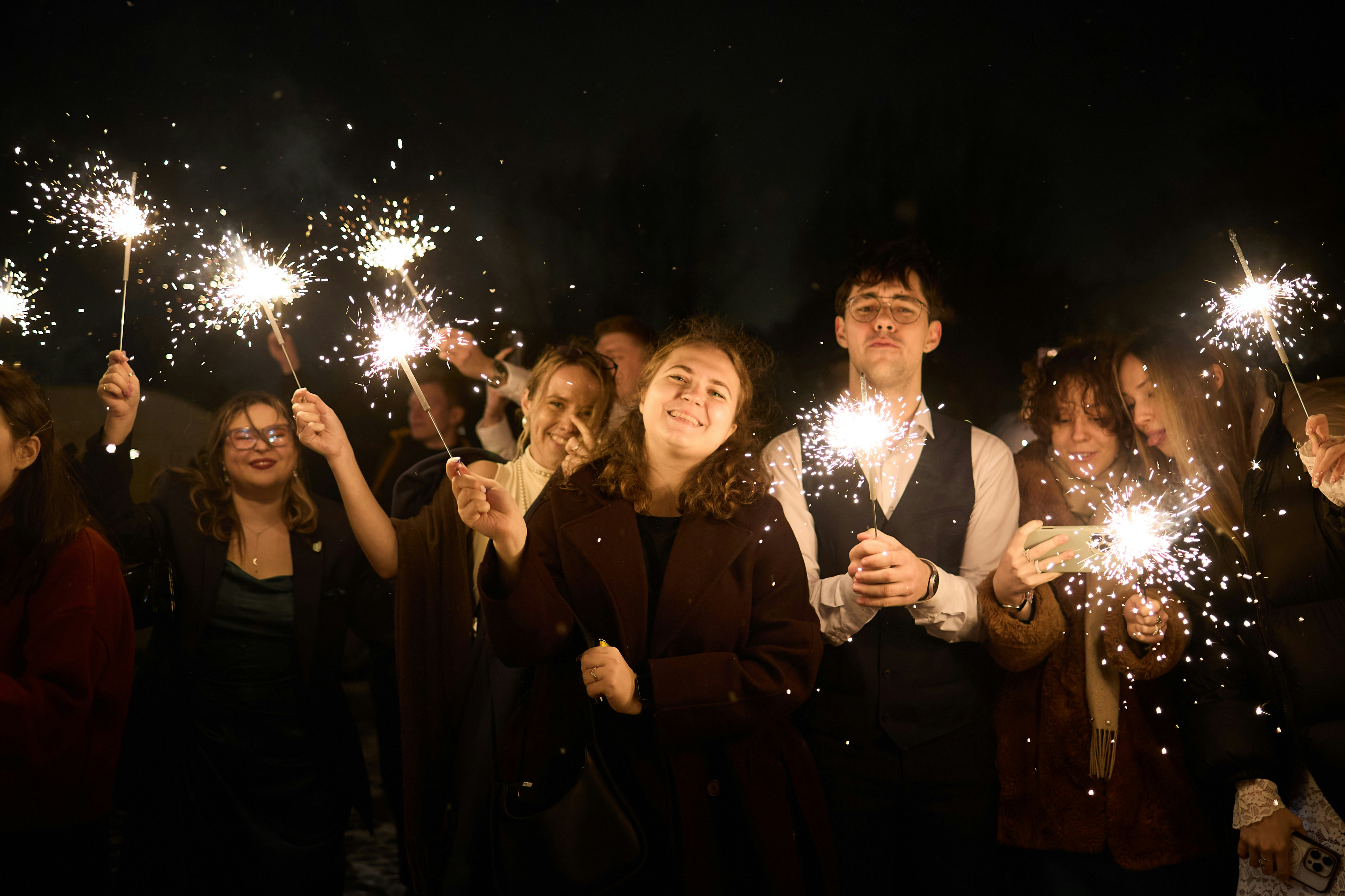 People celebrating with sparklers at night photo – Free People Image on ...