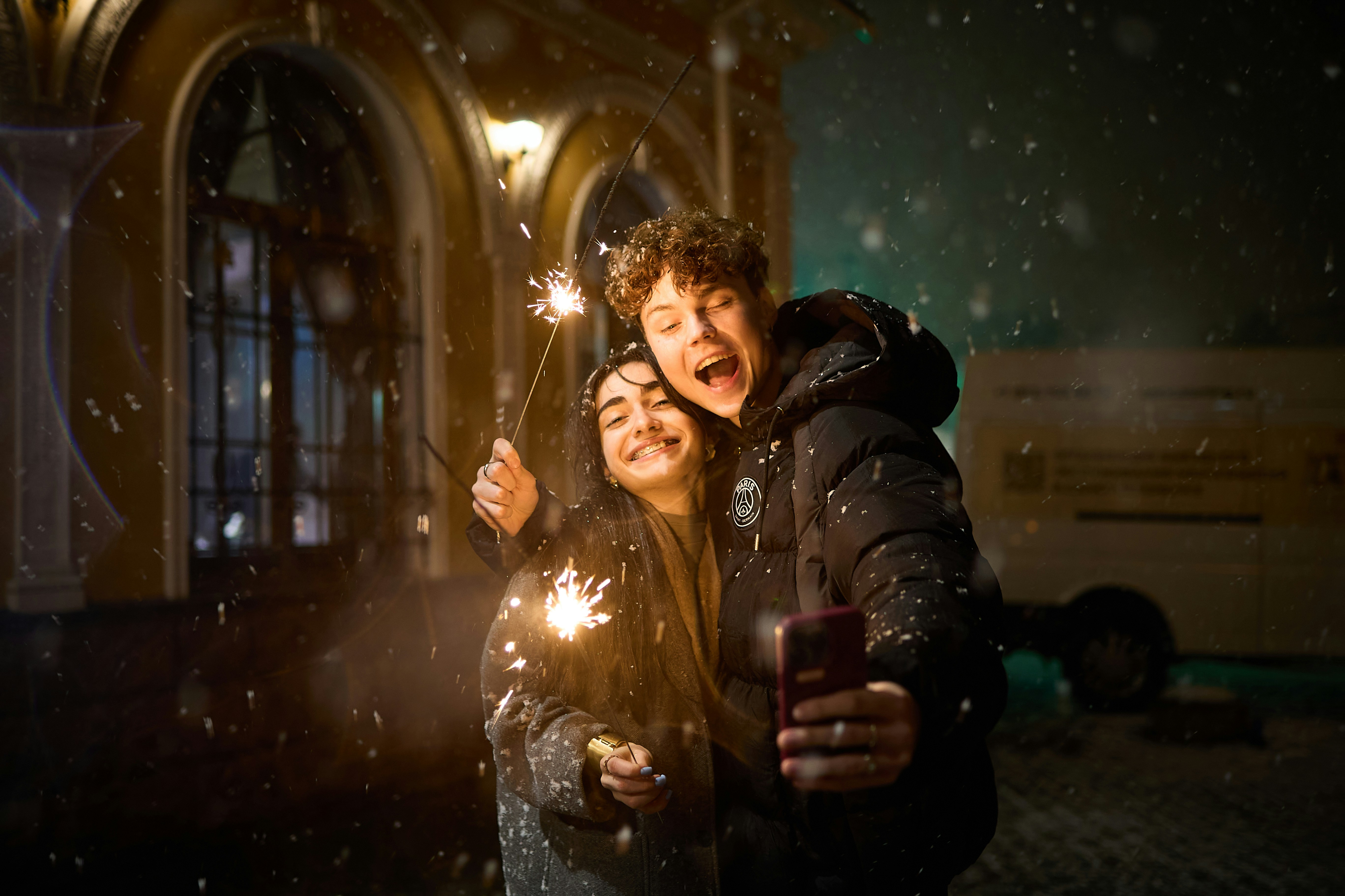 Selfie Sparks: Nighttime Laughter Under Sparkler Light