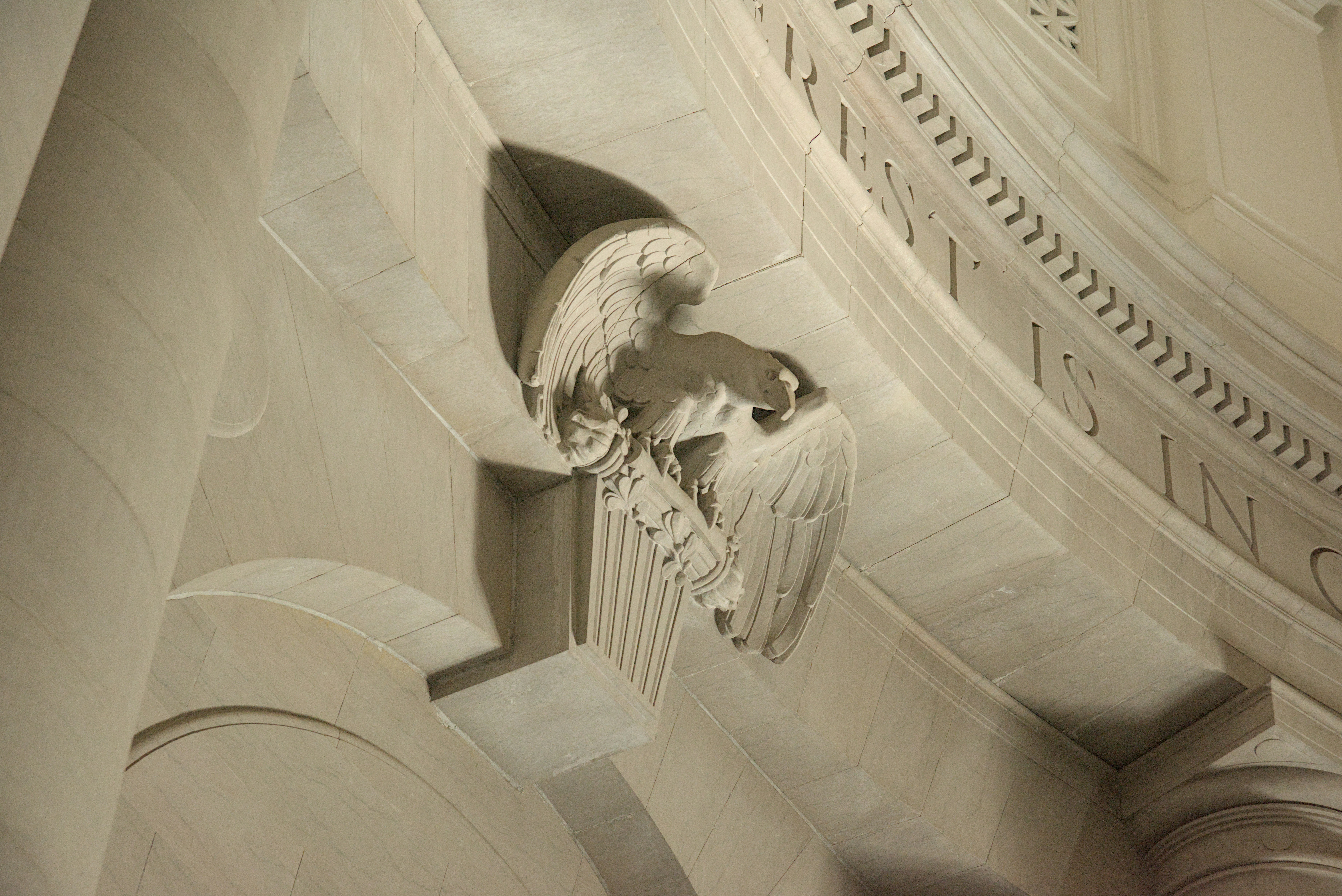 Sepia Sentinel: Winged Carving Guards the Facade